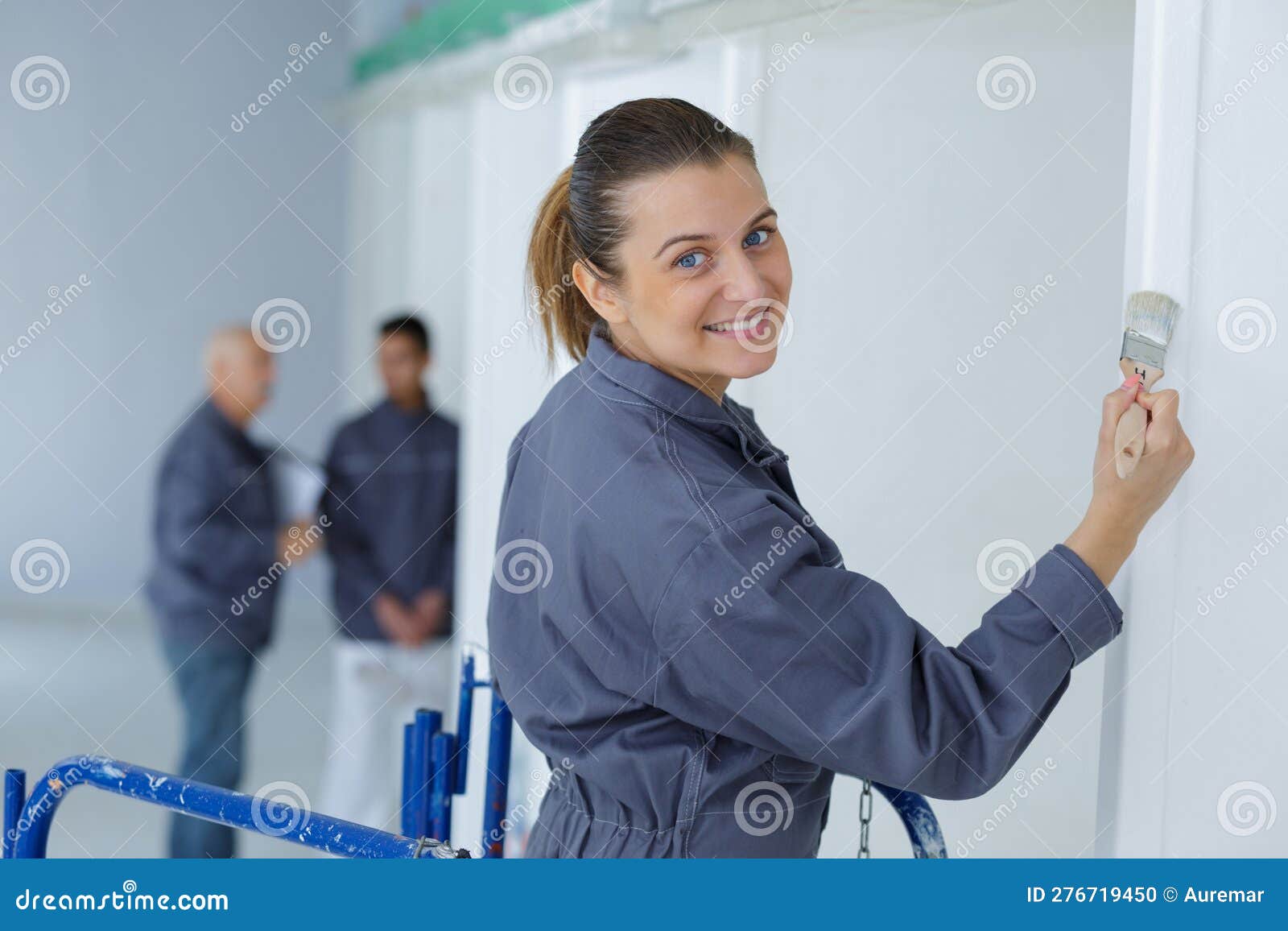 Apprentice Posing while Painting Wall Stock Photo - Image of equipment ...