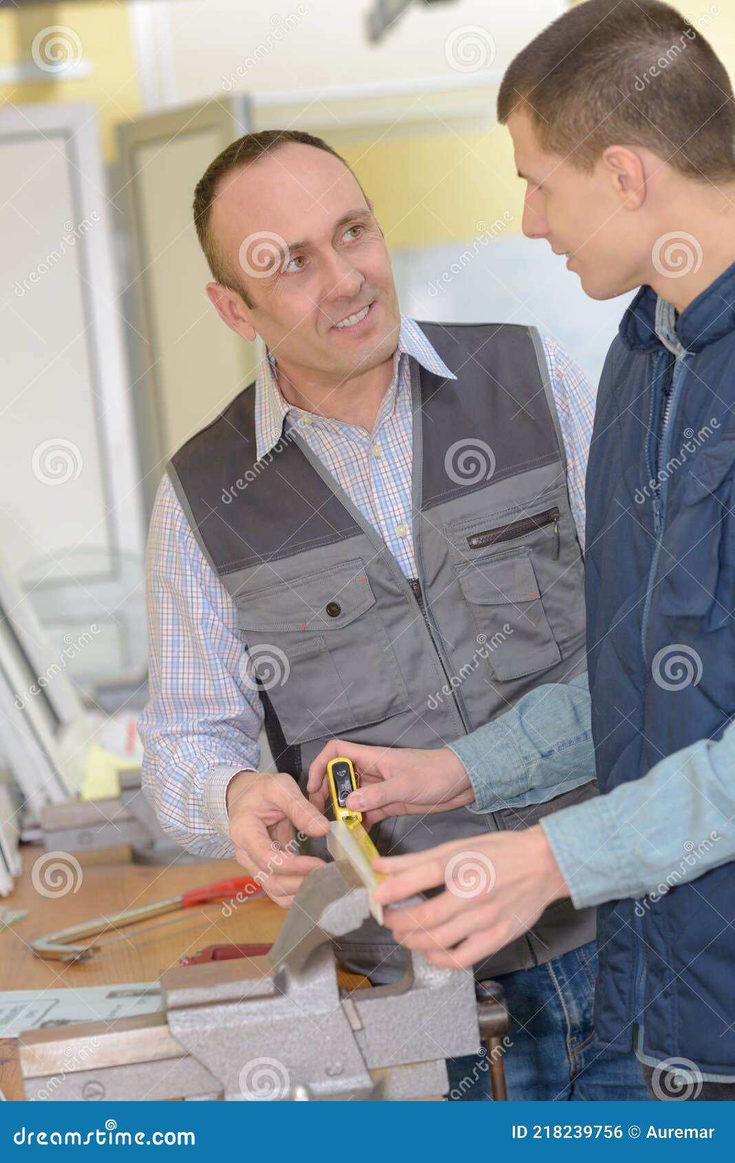 Apprentice with Supervisor Measuring Object in Vise Stock Photo - Image ...
