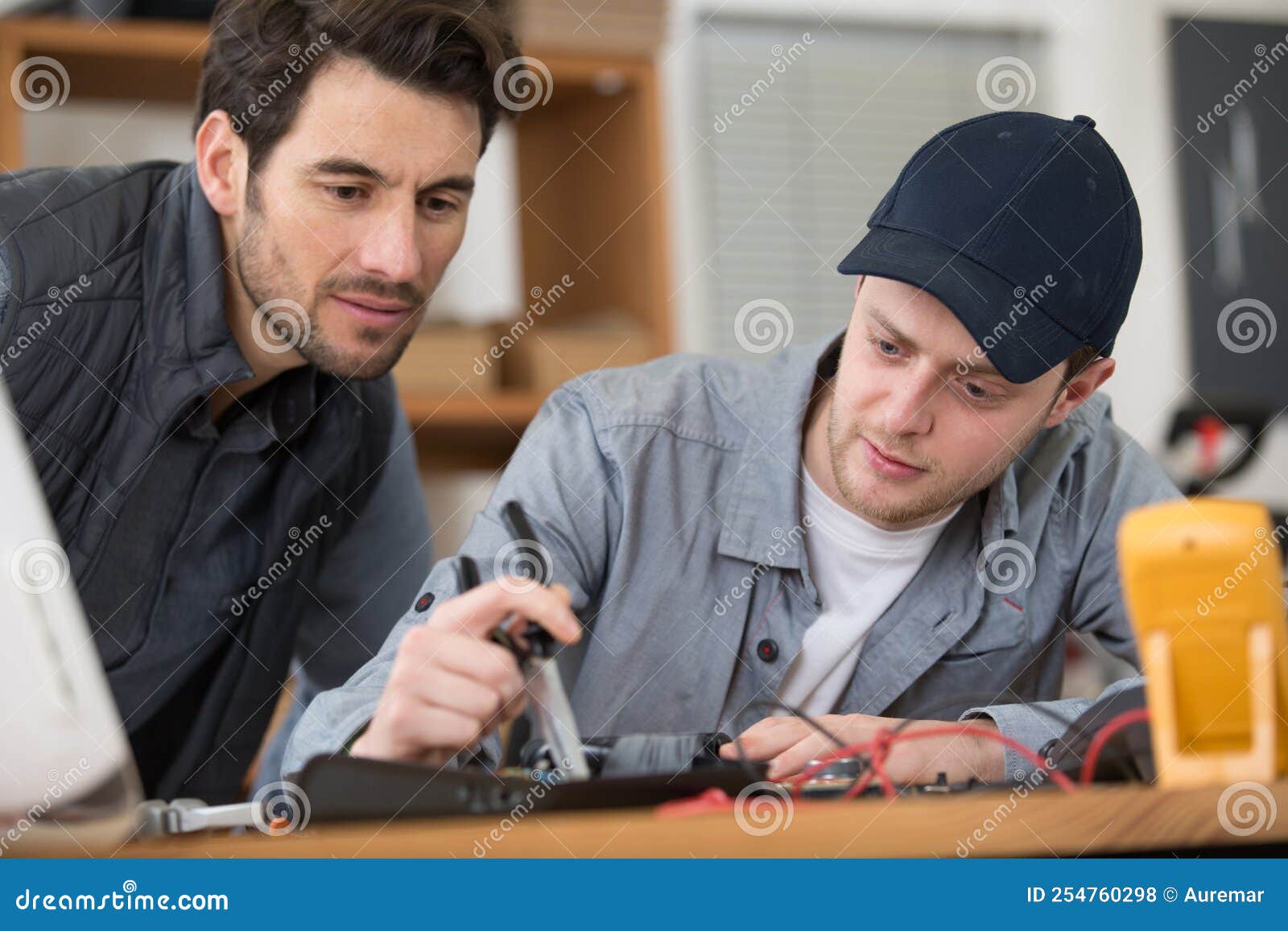 Apprentice Technician Working Under Supervision Stock Photo - Image of ...