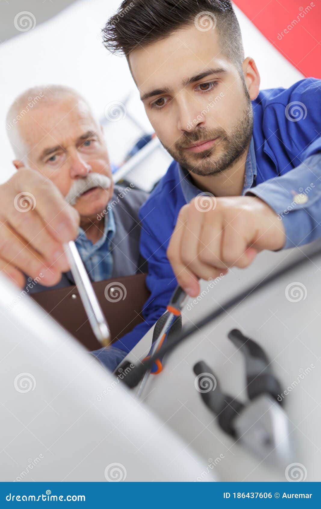 Apprentice Tradesman Under Supervision Stock Photo - Image of pliers ...
