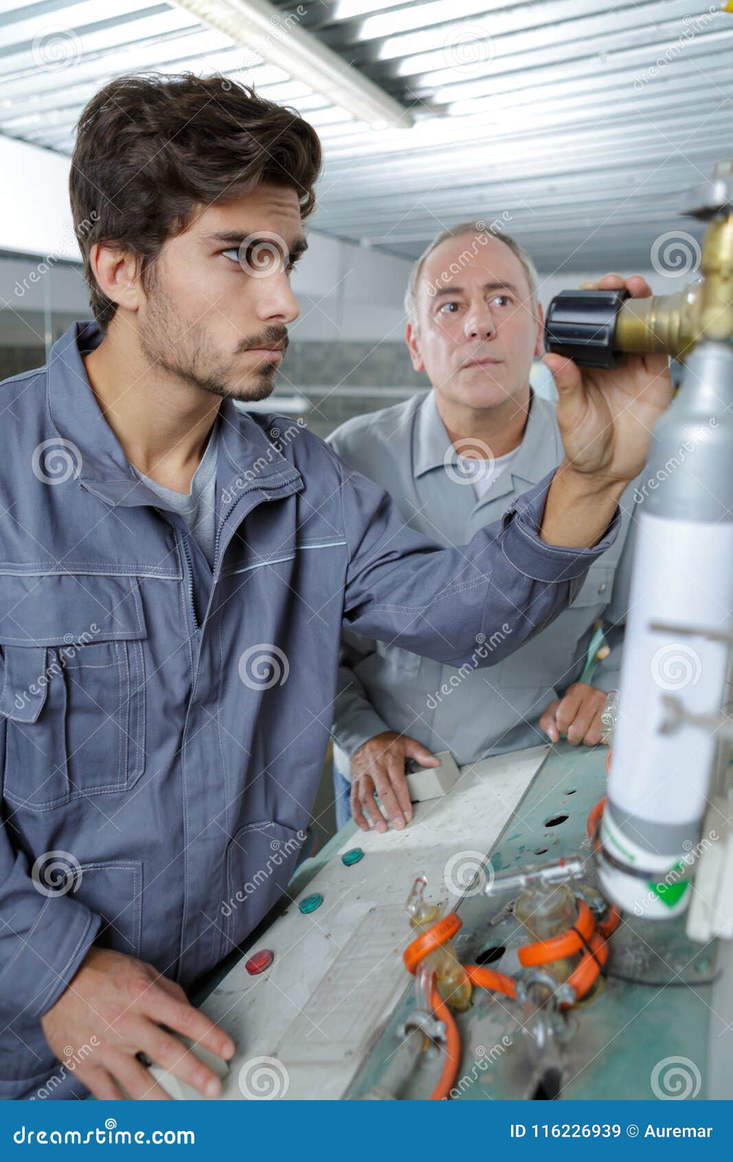 Apprentice turning a knob stock image. Image of machinery - 116226939