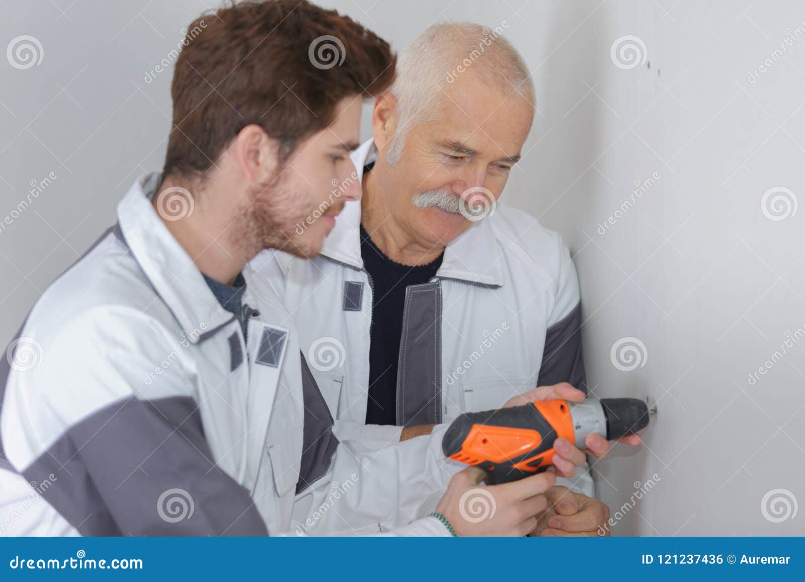 Apprentice Using Drill Under Supervision Stock Photo - Image of ...