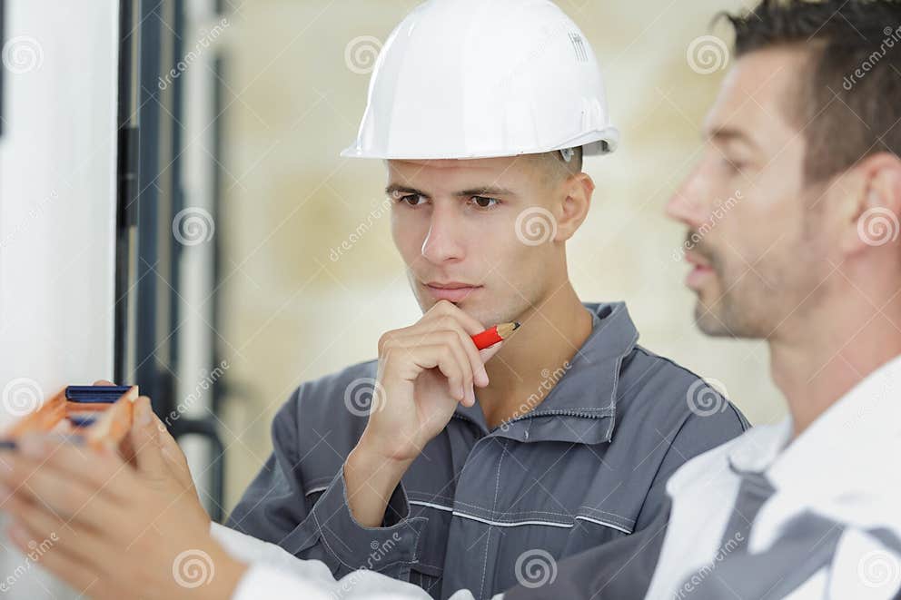 Apprentice Watching Foreman Use Spirit Level Stock Photo - Image of ... Apprentice Watching Foreman Use Spirit Level Stock Photo - Image of ...