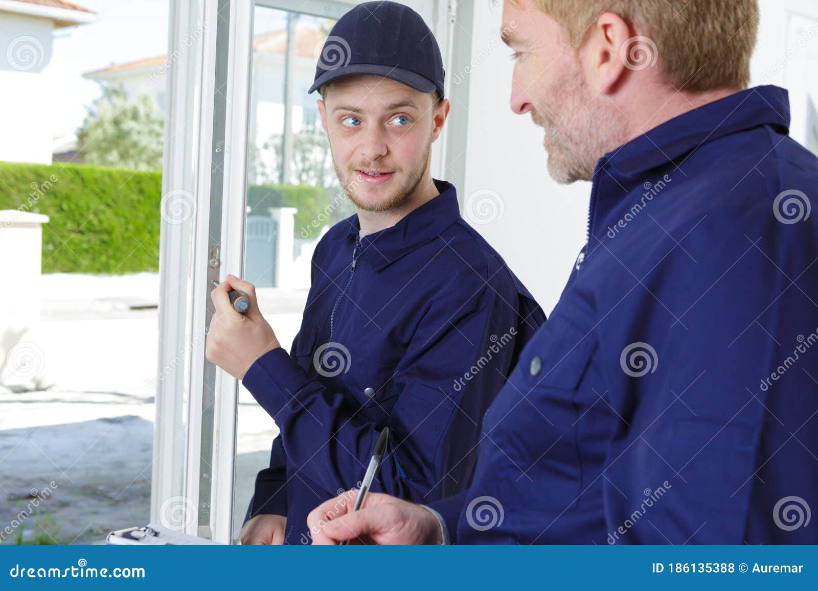Apprentice Window Fitter Working Under Supervision Stock Photo - Image ...
