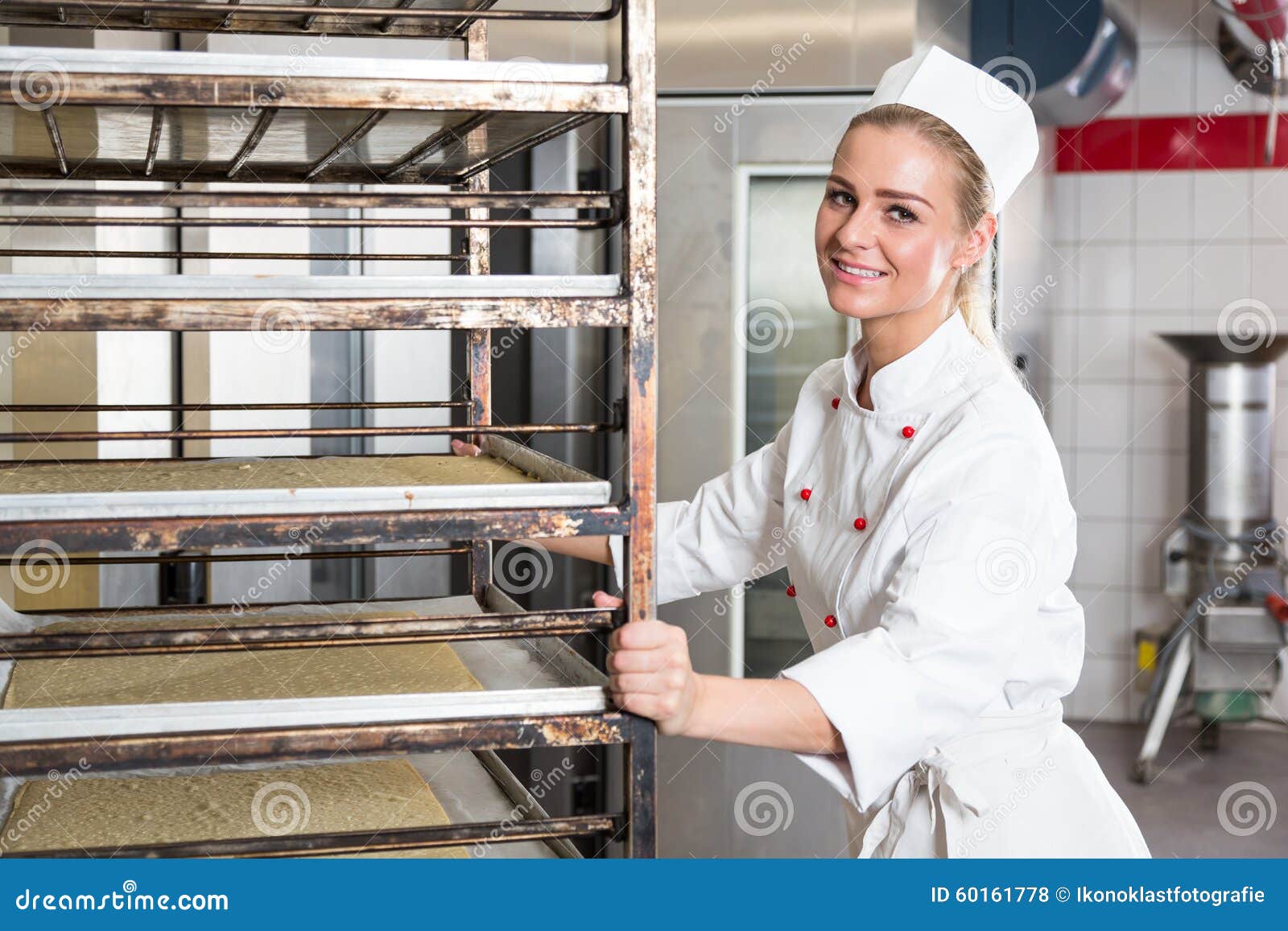 Apprentice or Worker in Bakery Push Rack with Dough Stock Photo - Image ...
