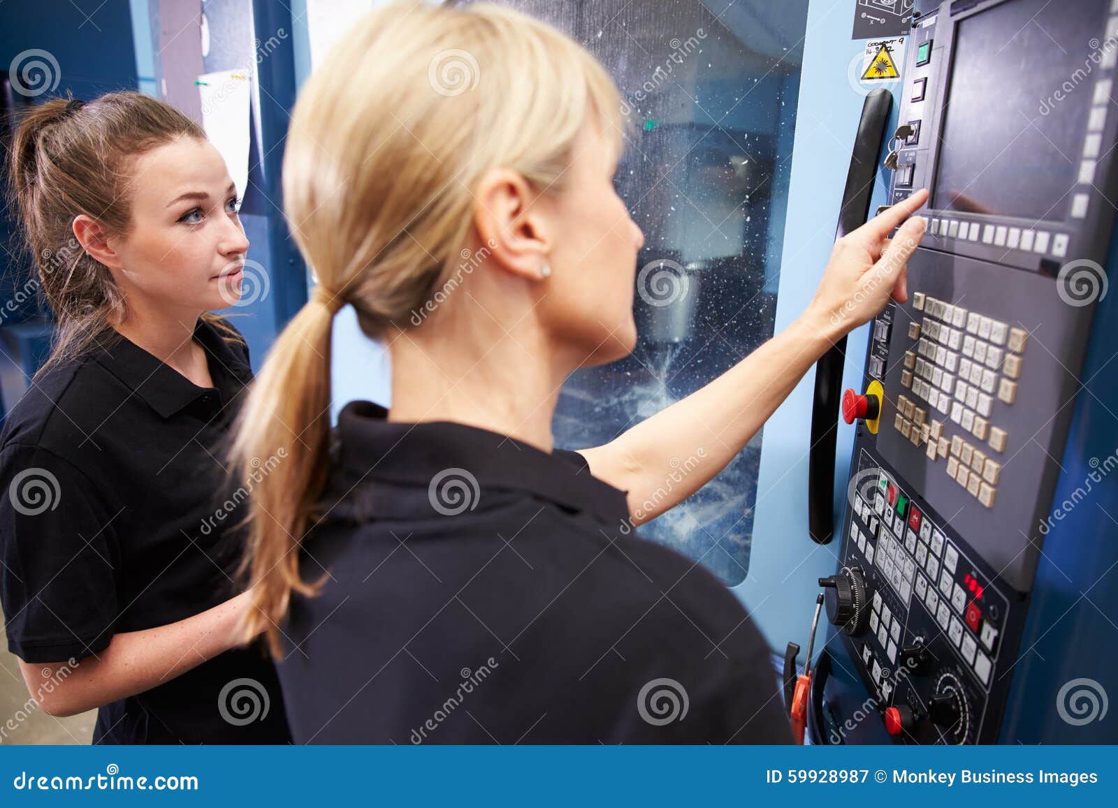 Apprentice Working with Female Engineer on CNC Machinery Stock Image ...
