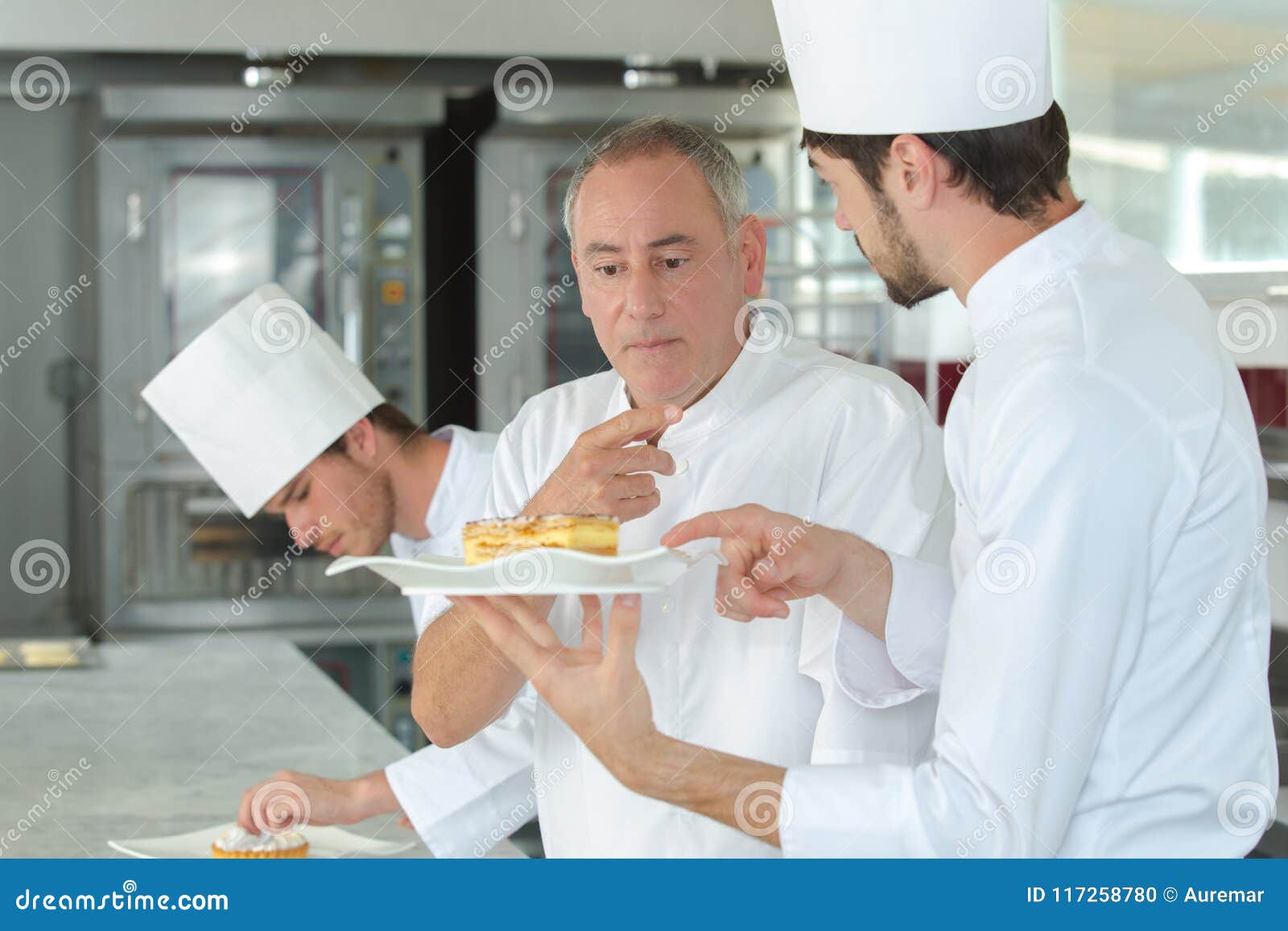 Apprentices Chefs at Work with Experienced Master Stock Photo - Image ...