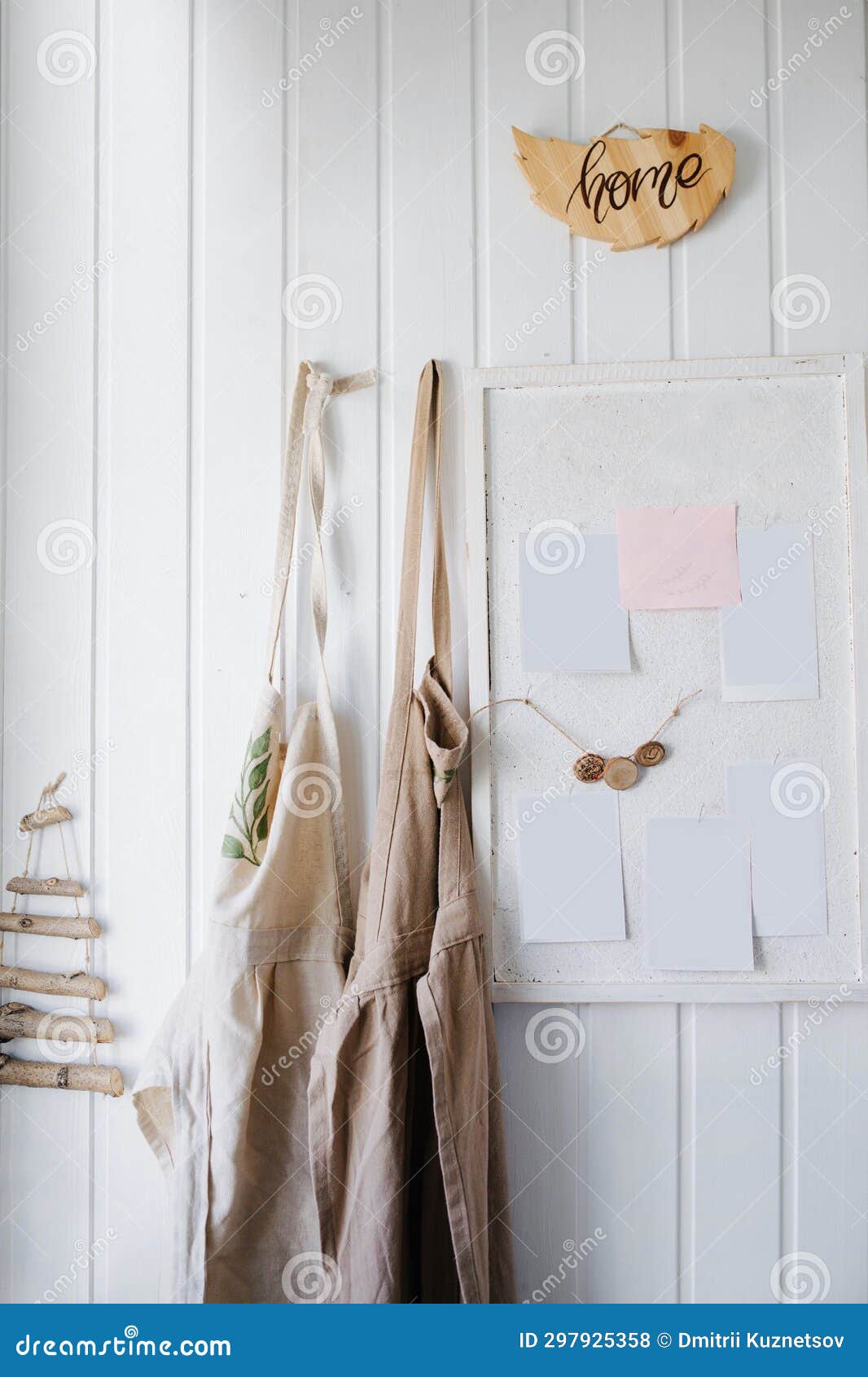 Aprons and a Board for Notes Hang on a White Wall Stock Photo - Image ...