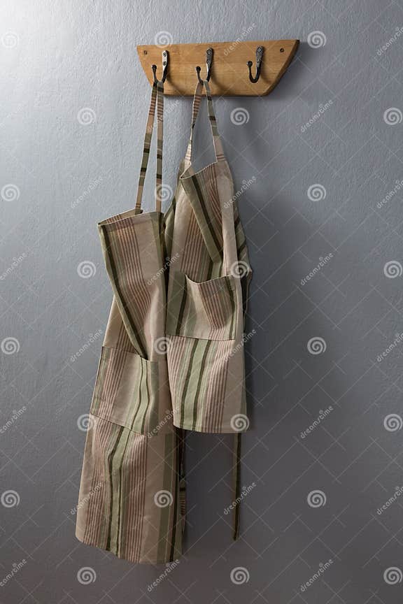 Aprons hanging on hook stock image. Image of textile - 103784371