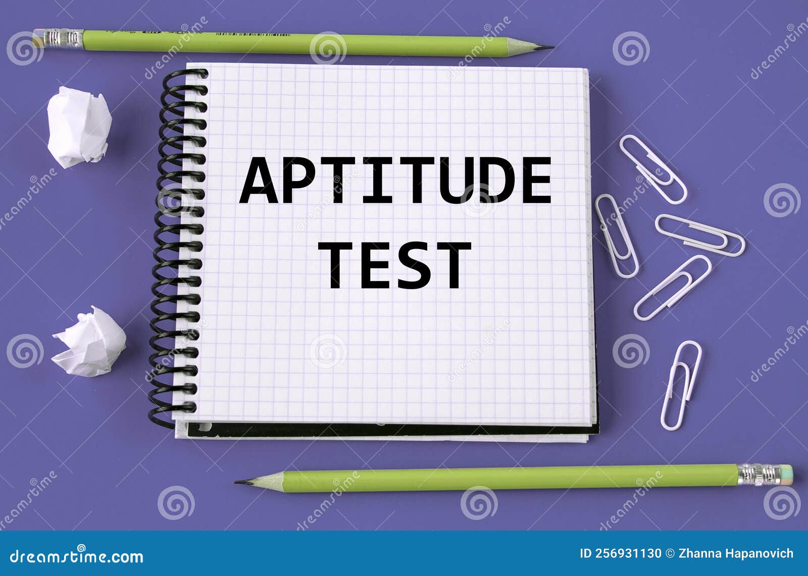 APTITUDE TEST- Words in a White Notebook on a Blue Background with ...