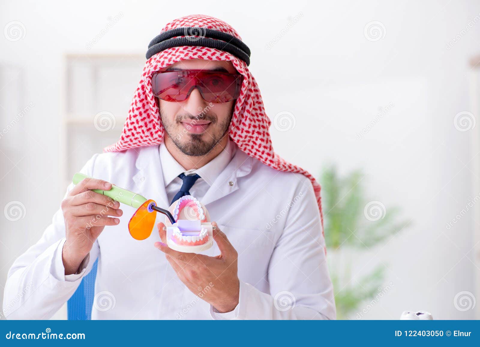 The Arab Dentist Working on New Teeth Implant Stock Photo - Image of ...