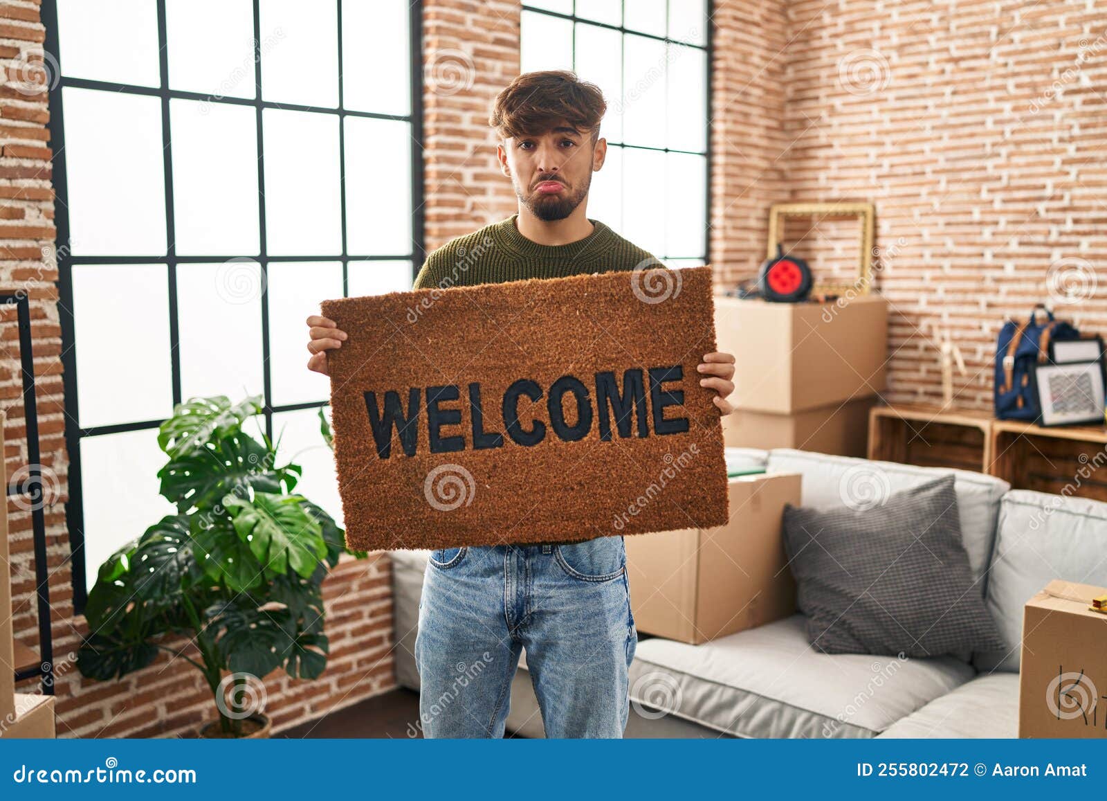 Arab Man with Beard Holding Welcome Doormat Depressed and Worry for ...
