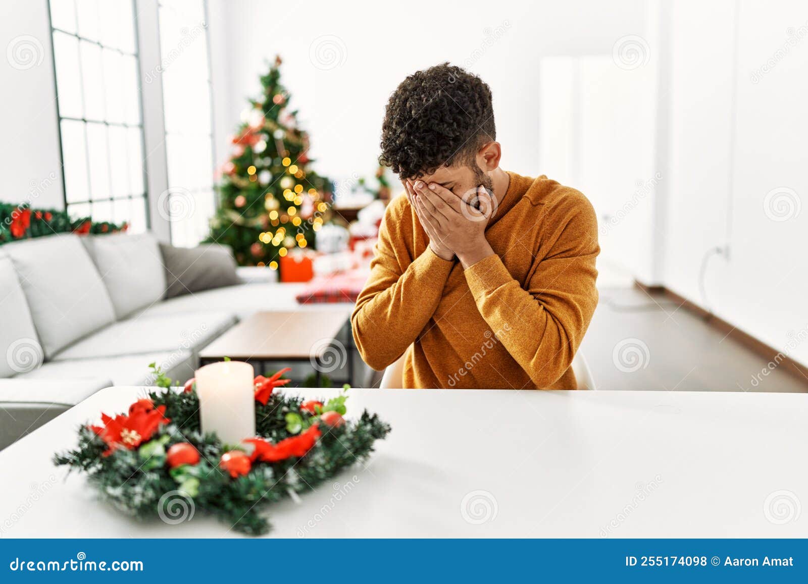 Arab Young Man Sitting on the Table by Christmas Tree with Sad ...