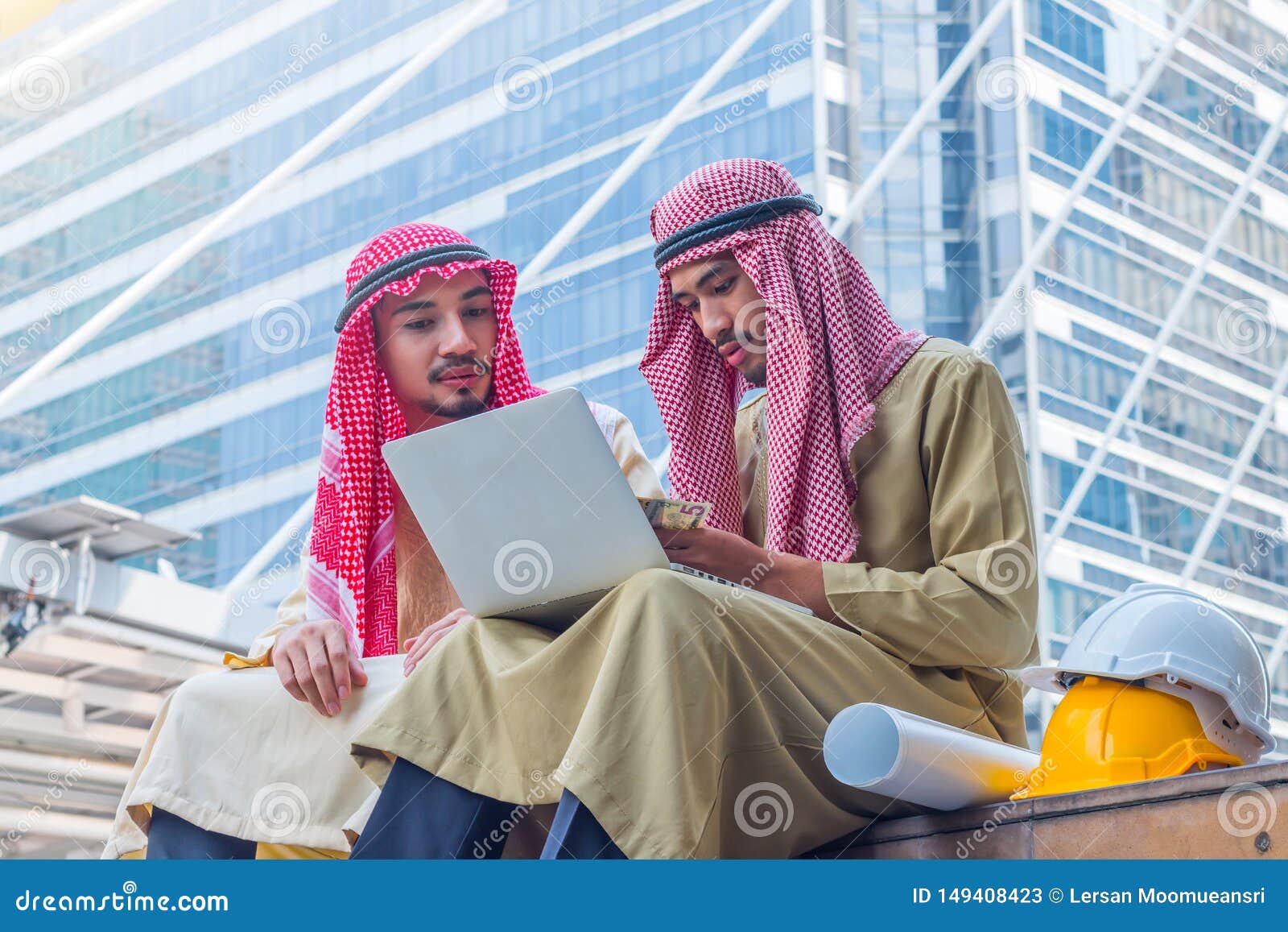 The Arabian Engineer Talking About Construction Job With Laptop In ...