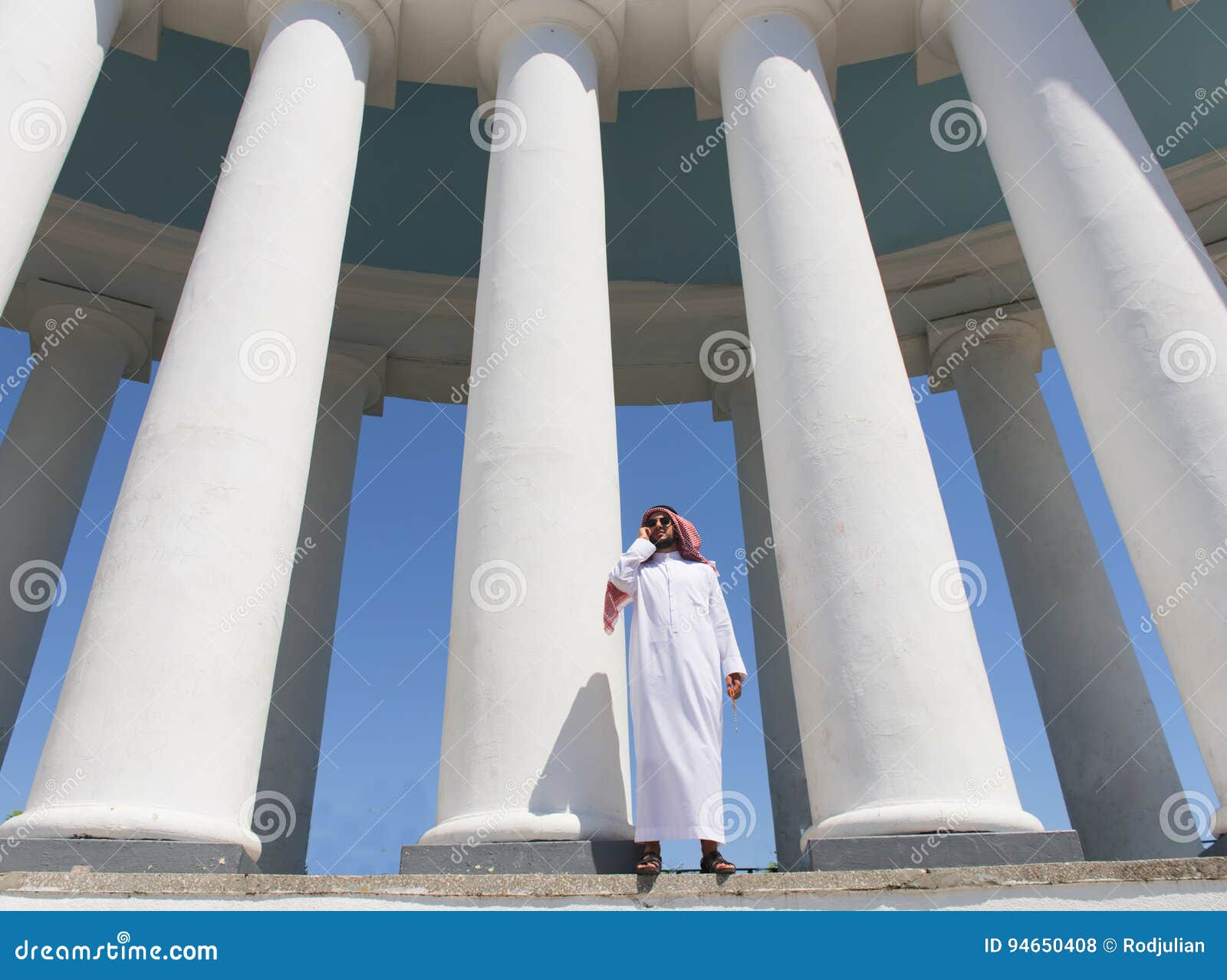 Arabian Man Standing in Front of Large Columns Stock Photo - Image of ...