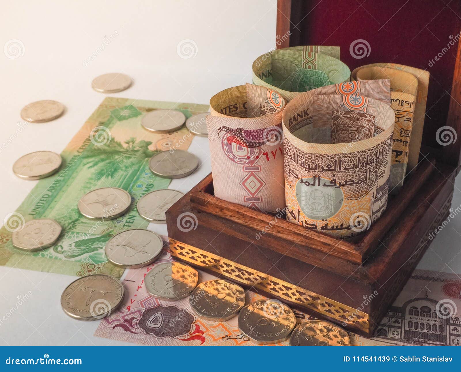 Arabic Coins of Dirhams. Curled Banknotes in His Hands. Stock Image ...