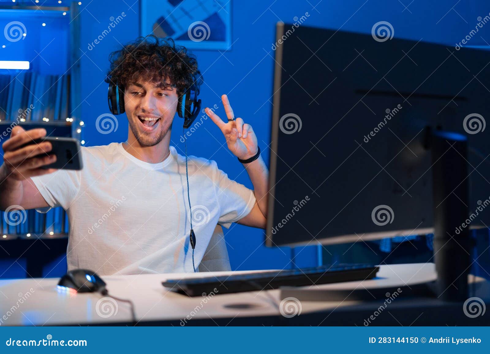 Arabic Guy Gamer in a Headset Playing Computer Games Sits at a Computer ...