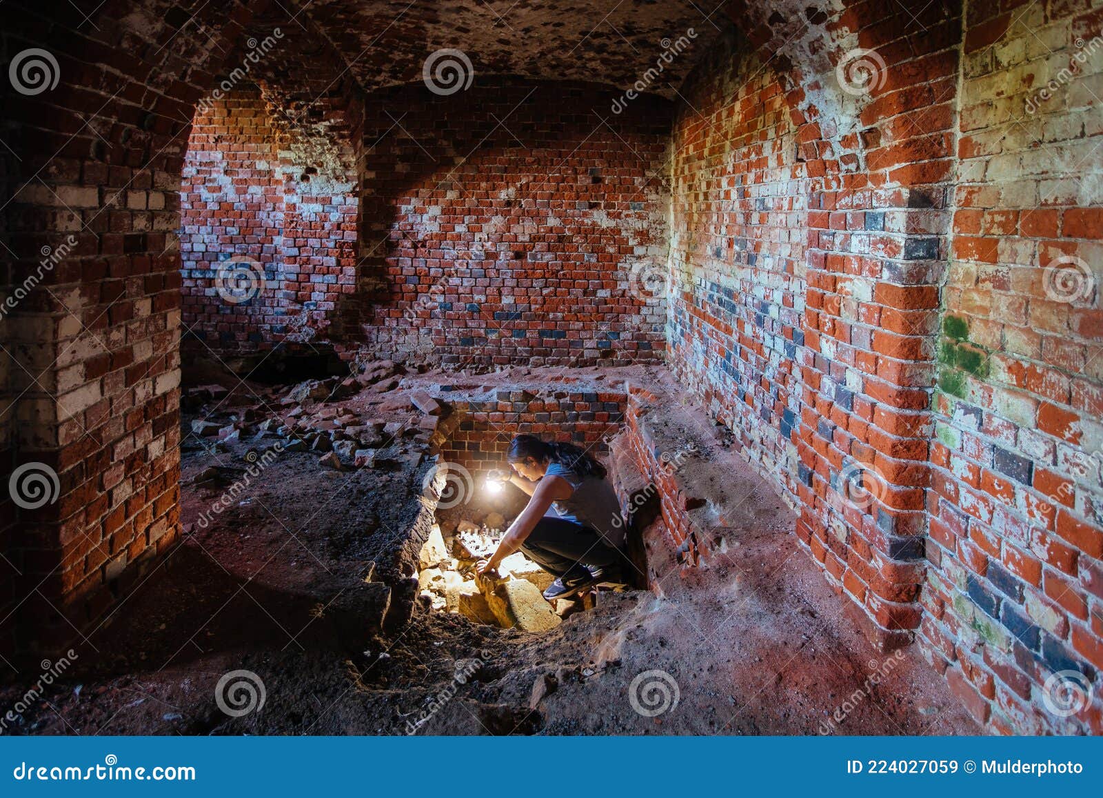 Archaeologist with Flashlight Examines the Old Crypt Under Church Stock ...