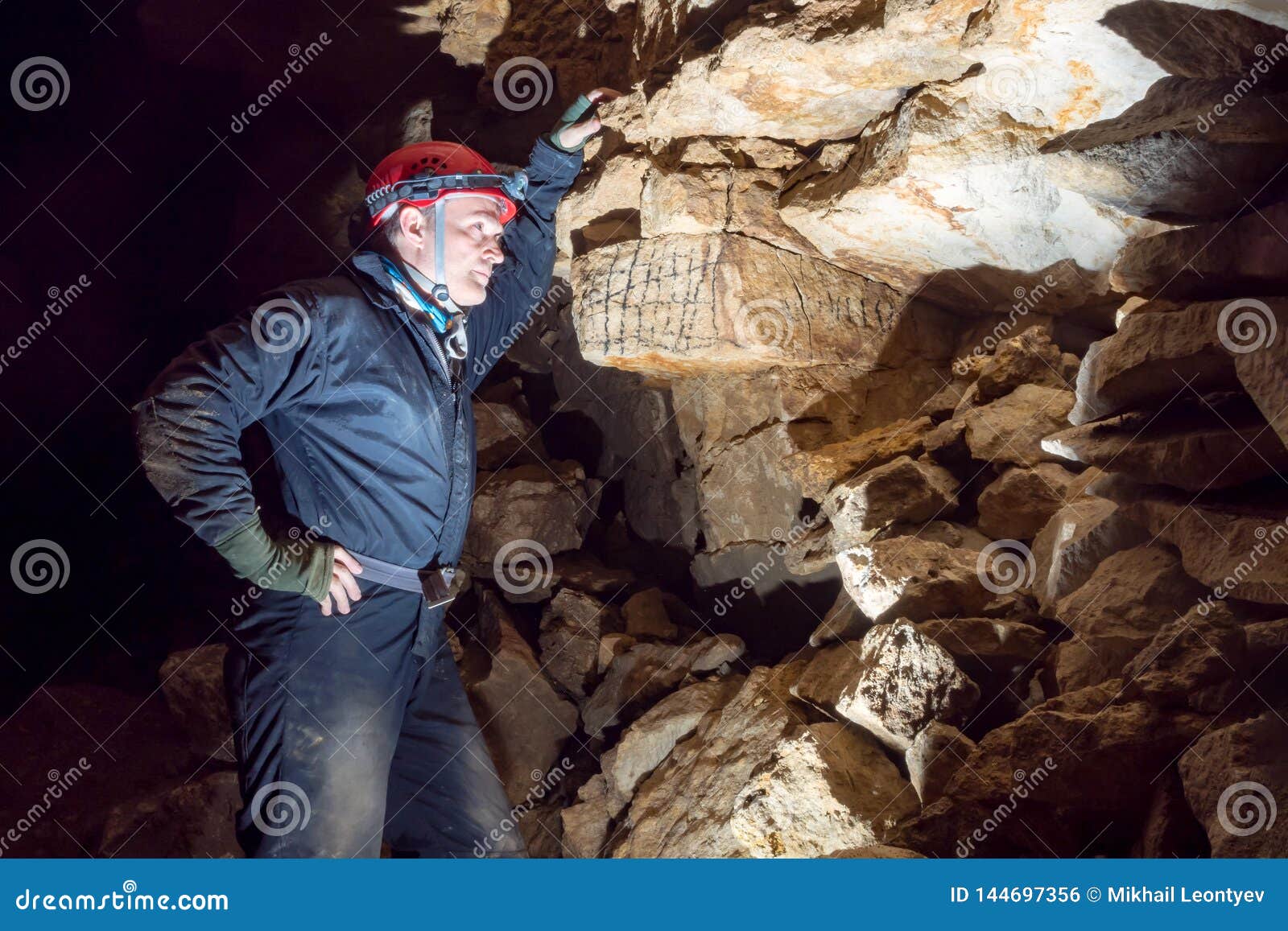 Archaeologist Look at the Drawing on Stone Wall in the Caves Stock ...