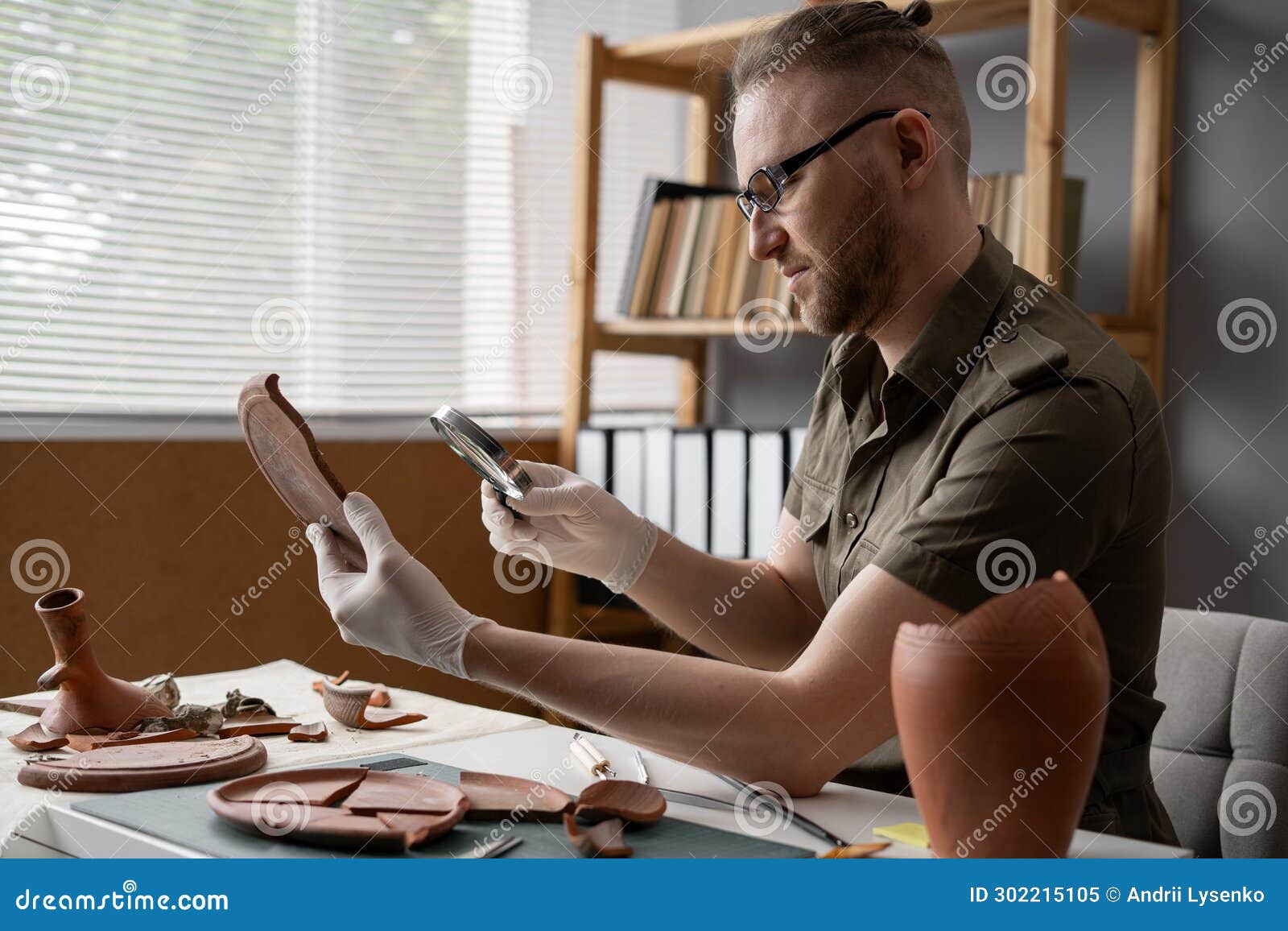 Archaeologist Using Magnifying Glass Working in Office To Study ...