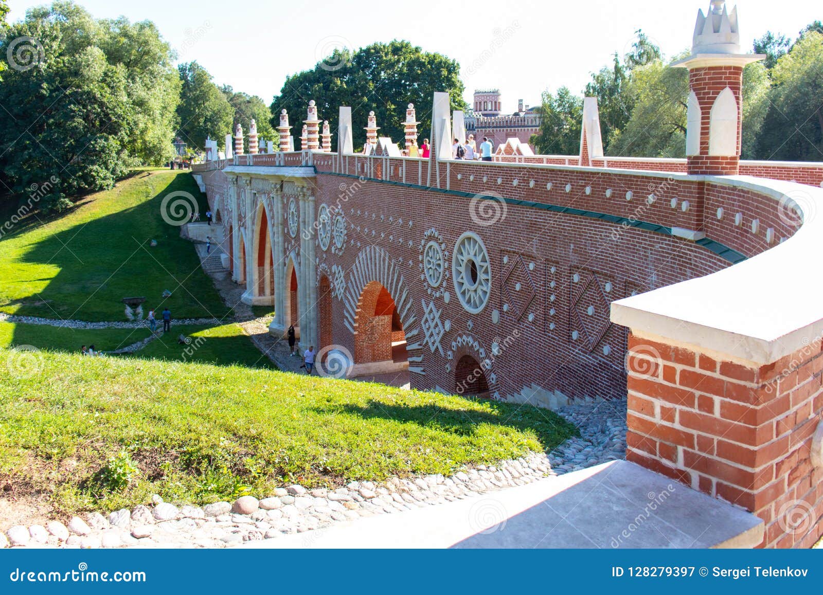 Arched Bridge of Red Brick with White Elements. Green Grass, White ...