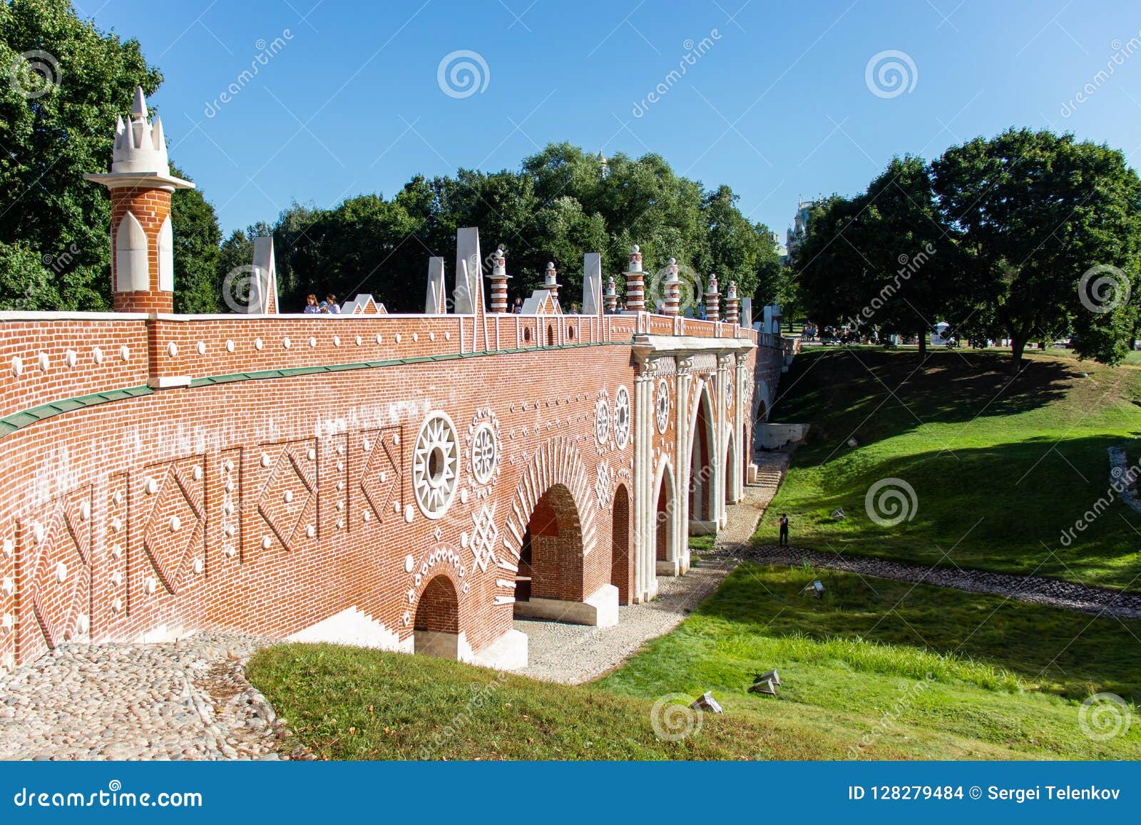 Arched Bridge of Red Brick with White Elements. Green Grass, White ...