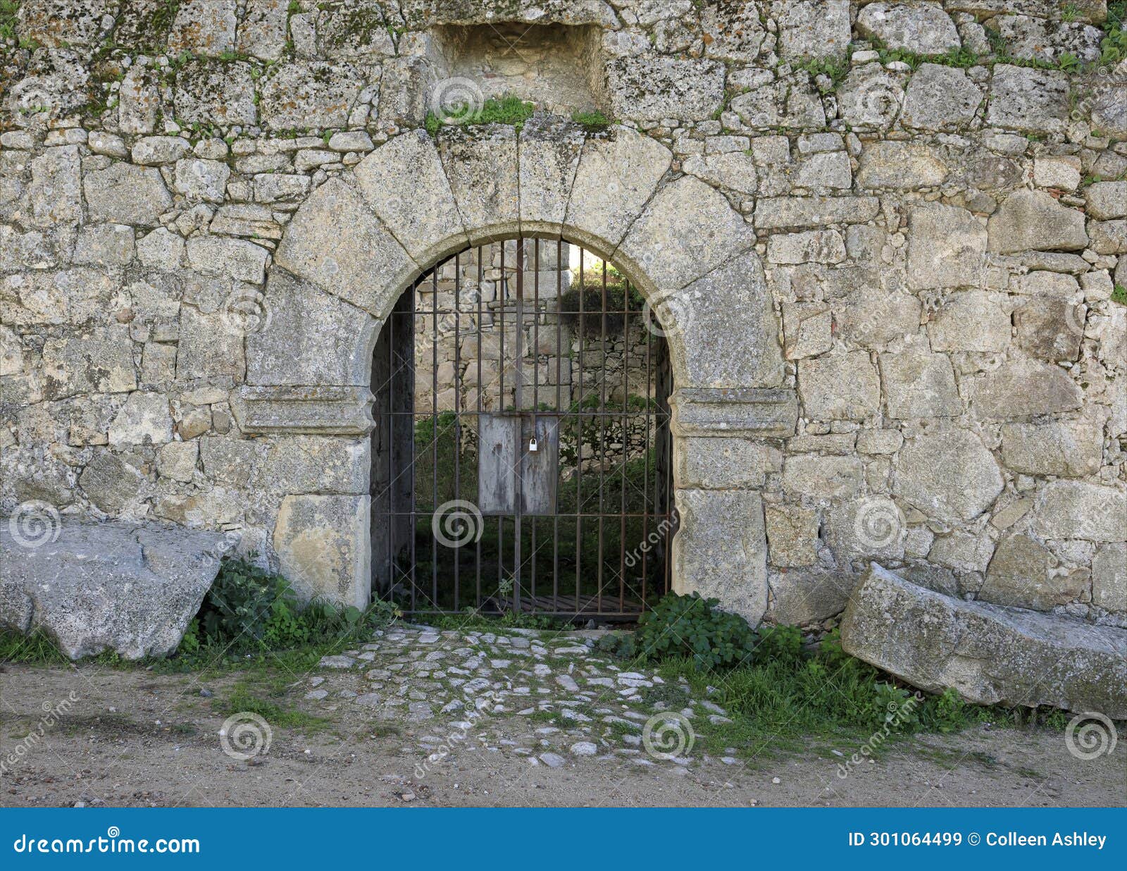 Arched Gateway with Iron Bars Which Can Be Seen through Stock Image ...