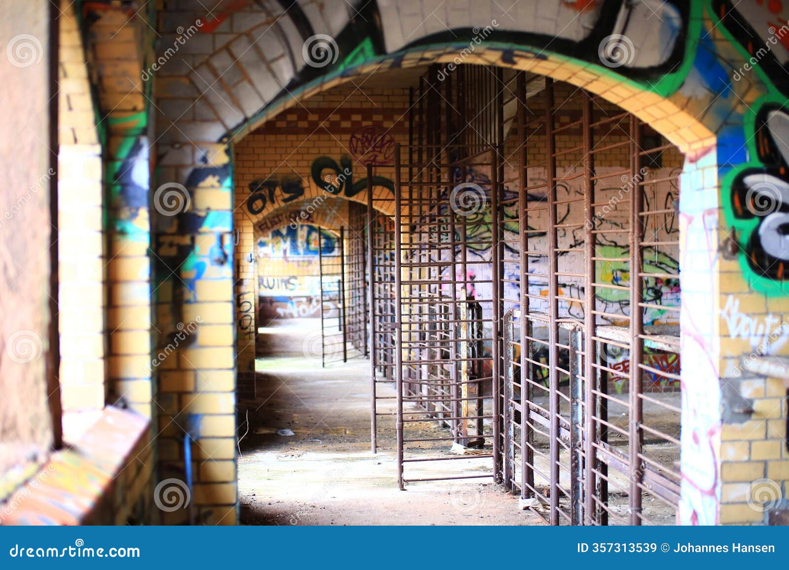 Arched Graffiti Corridor with Rusted Cells, Vibrant Walls, and Decaying ...