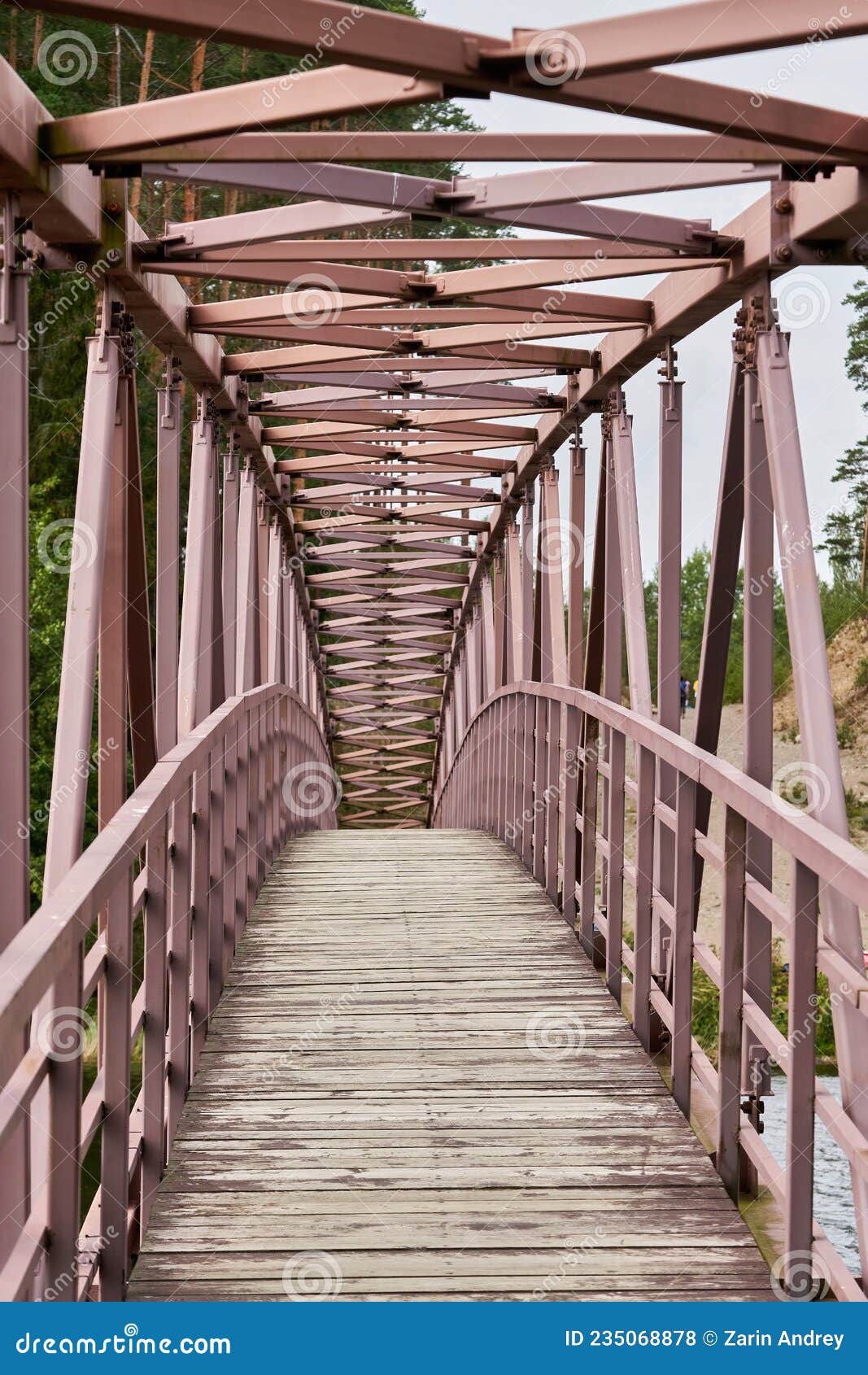 An Arched Pedestrian Bridge Over the River with a Wooden Deck Stock ...