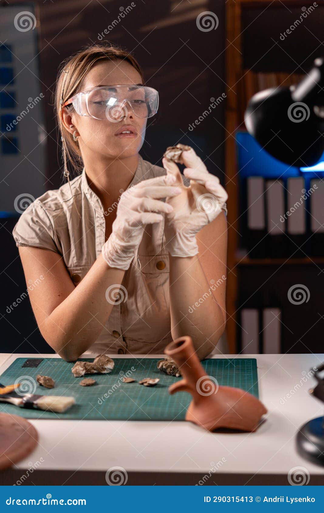 Archeologist Studying Artifacts, Working Late Night in Office. Stock ...