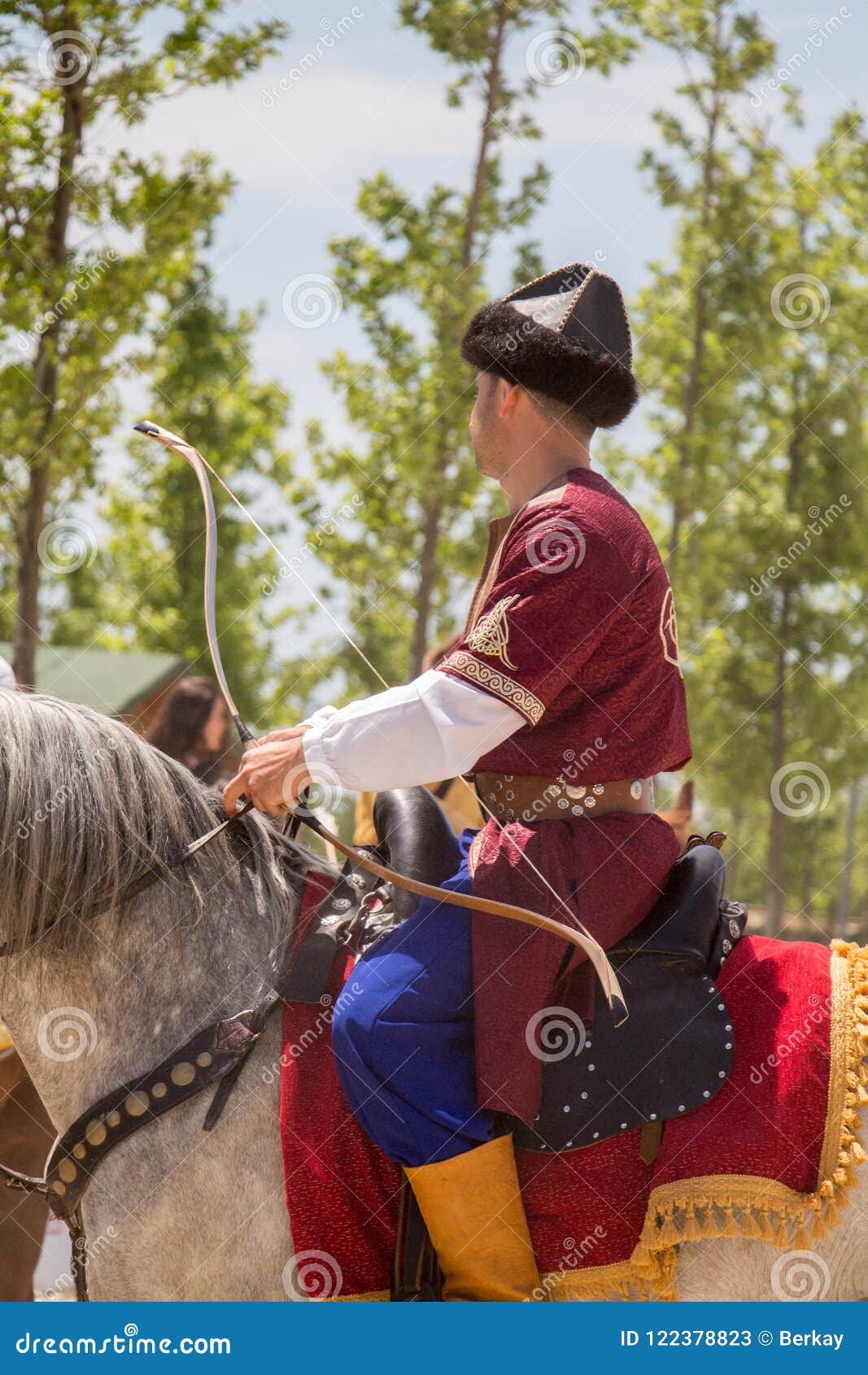 Archer In Traditional Clothes Shooting An Arrow Editorial Photo ...