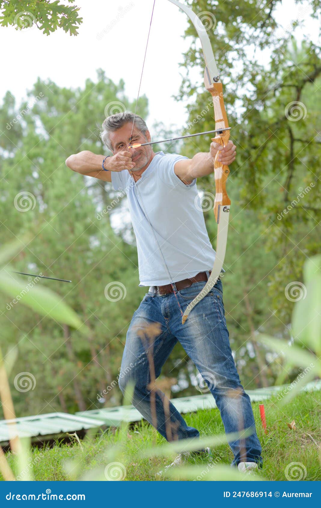 Archery Man Shooting Arrow with Bow in Nature Stock Photo - Image of ...