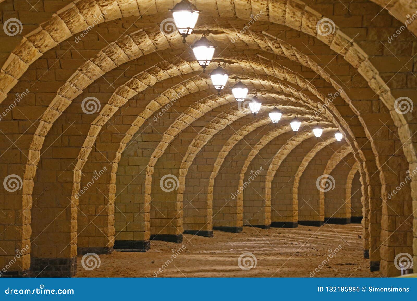 Arches Forming a Walk Way Under a Pier Lit at Night Stock Photo - Image ...