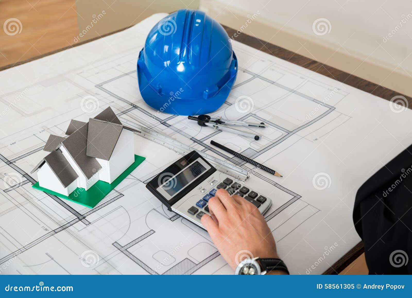 Architect with Blueprint Calculating on Calculator Stock Image - Image ...