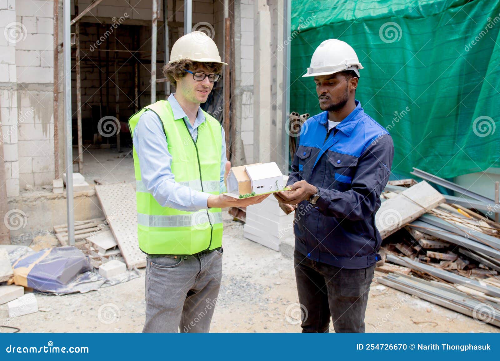 Architect and Builder Talking and Holding Model House at Construction ...