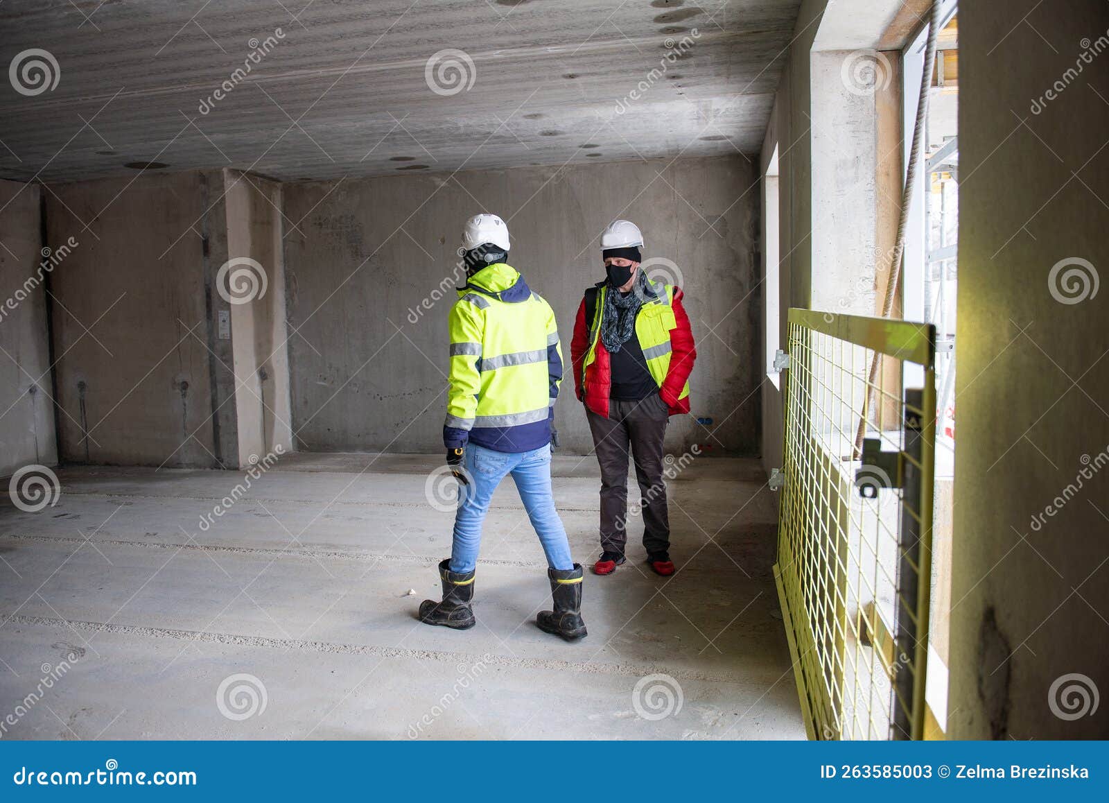 The Architect of the Building Project and the Construction Manager Walk ...