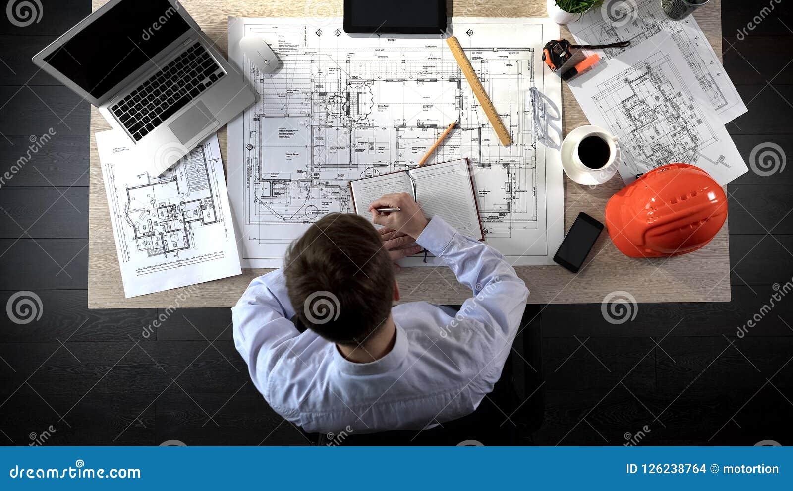 Architect Checking Drawing of Building, Making Notes To Discuss with ...