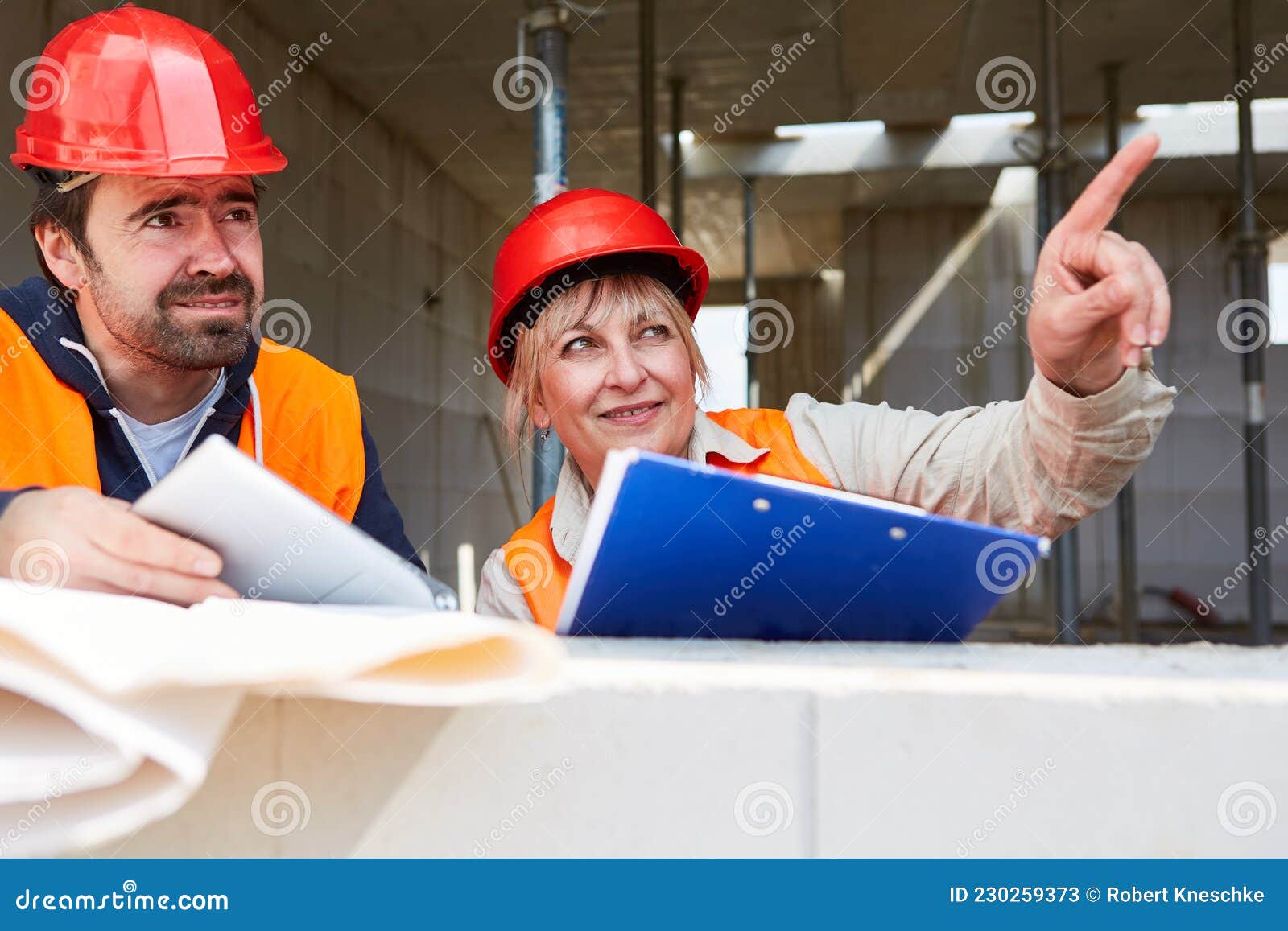 Architect on Construction Site Gives Workers an Instruction Stock Image ...
