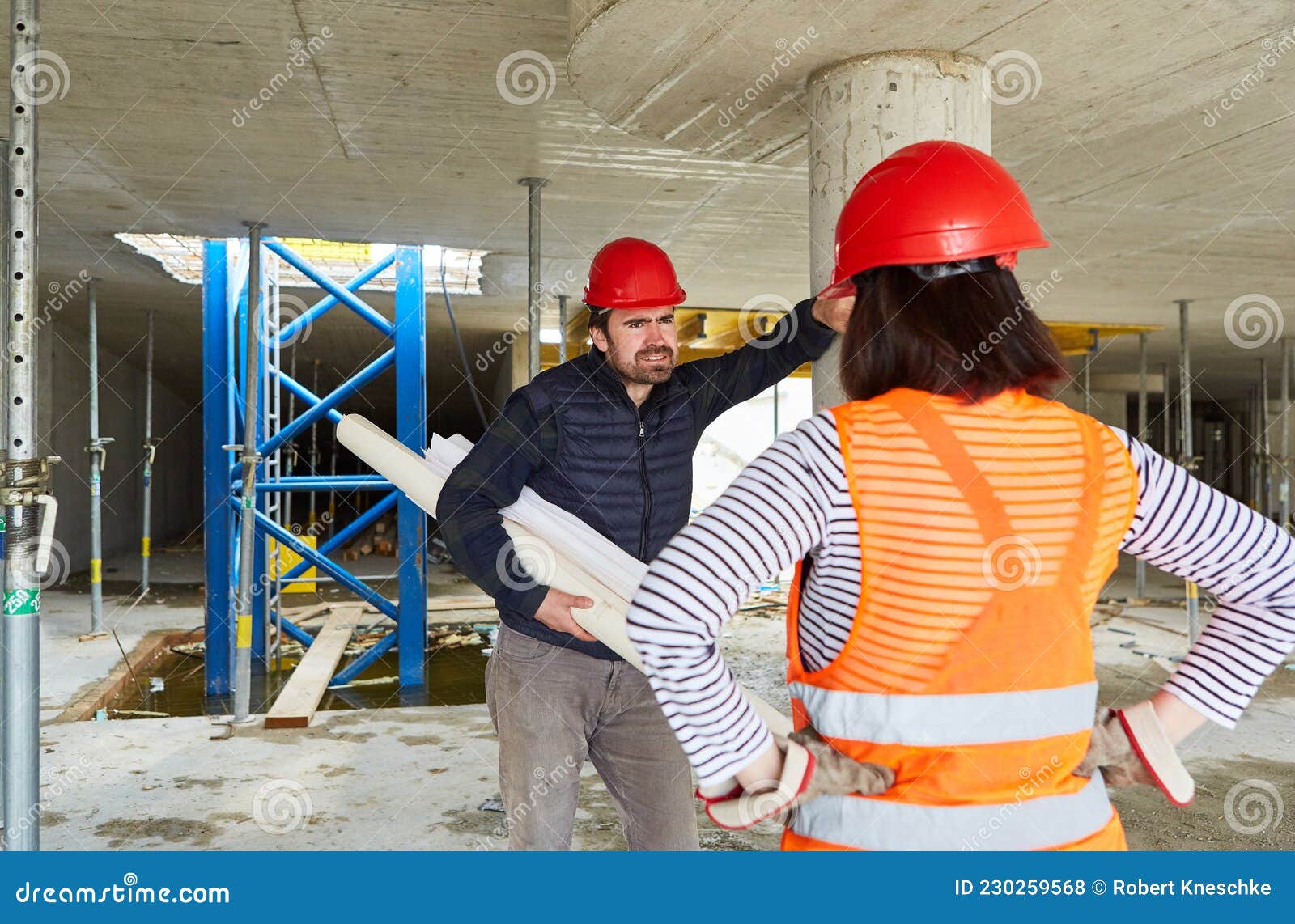 Architect and Construction Worker Discuss Construction Project Stock ...