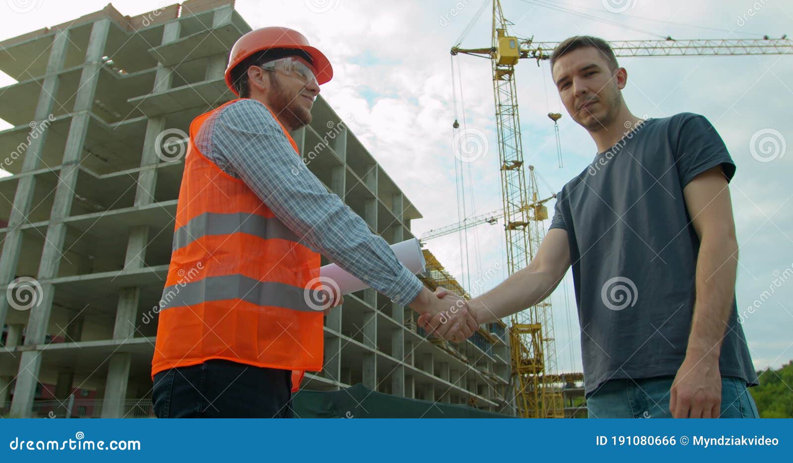 Architect Contractor Shaking Hands with Client at Construction Site ...
