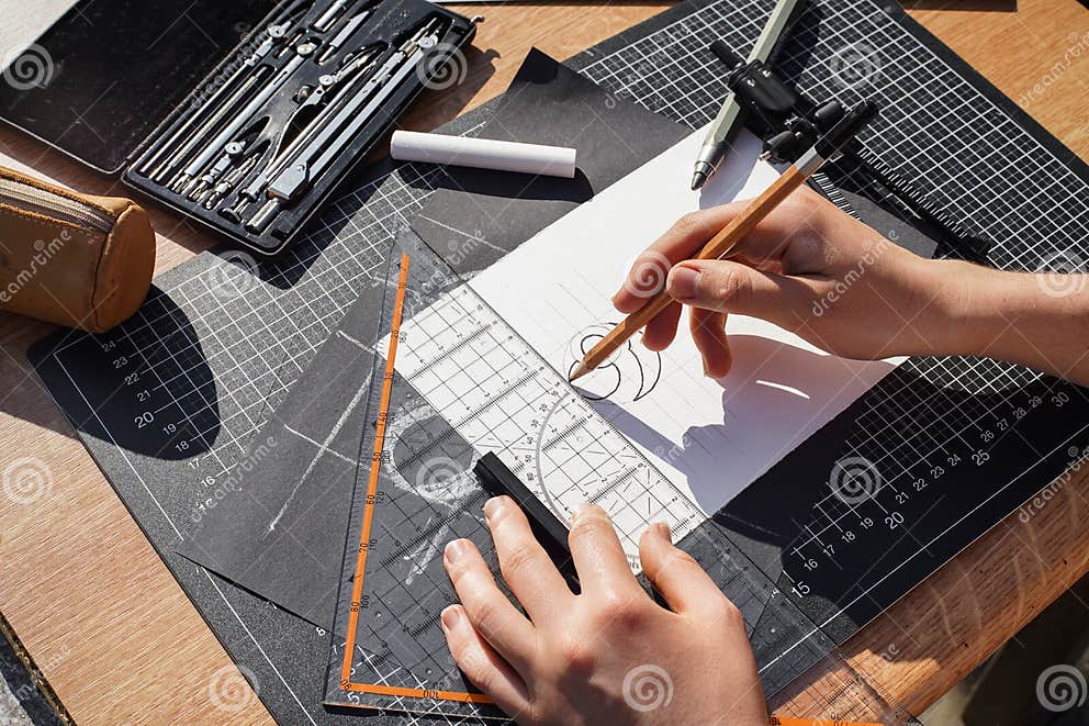 Architect and Designer Working Accurately on a Project Drawing Sketches and Technical Drafts on ...