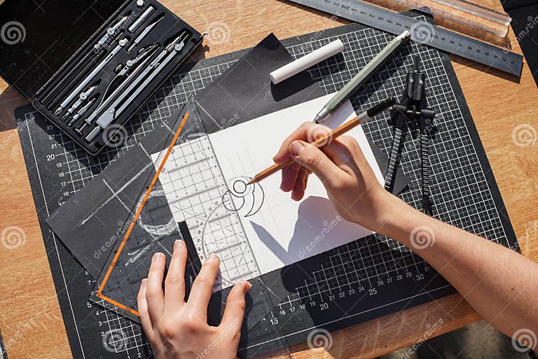 Architect and Designer Working Accurately on a Project Drawing Sketches and Technical Drafts on ...