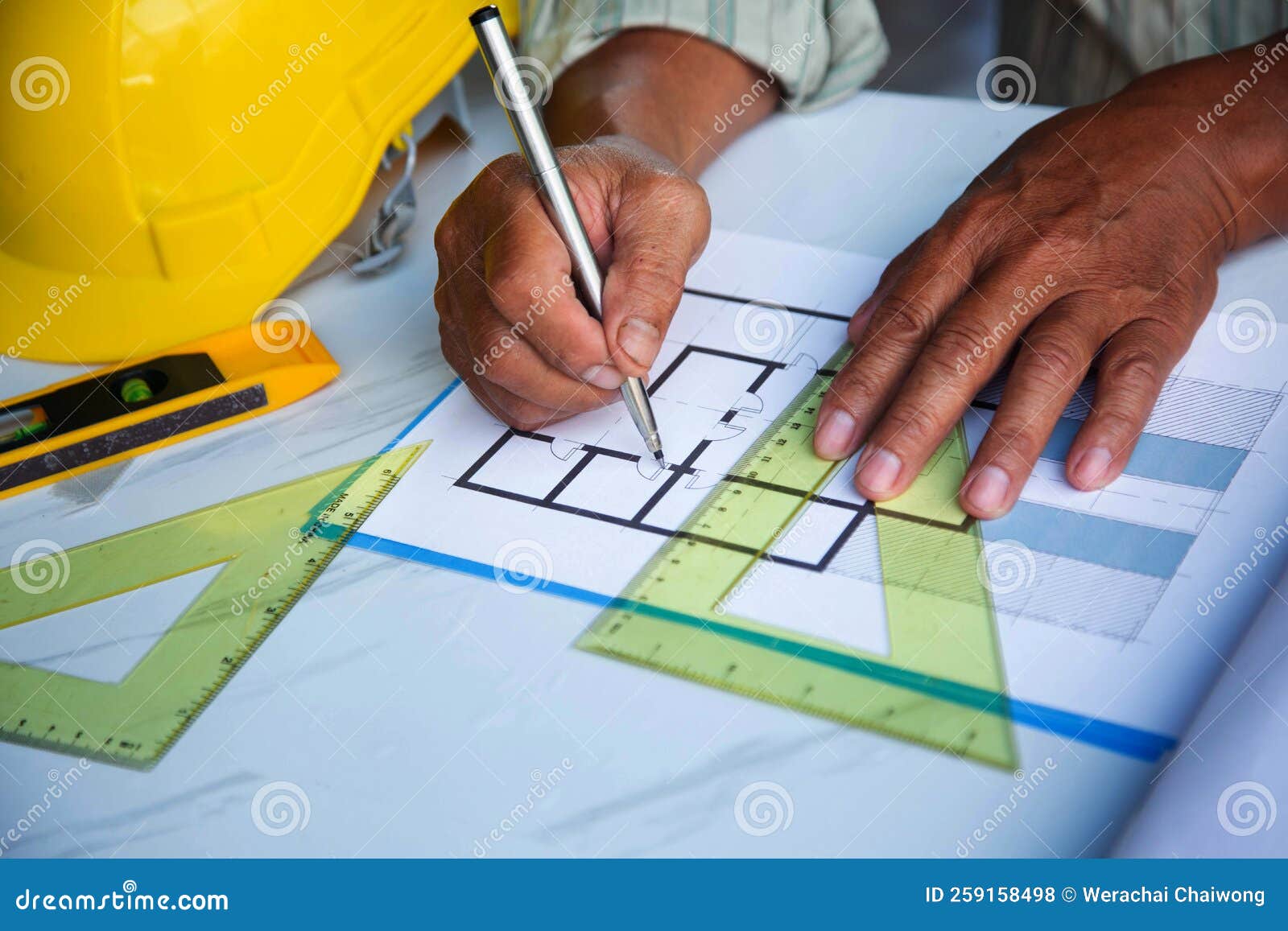 Architect Designing Project at Construction Site with Blueprint Stock ...