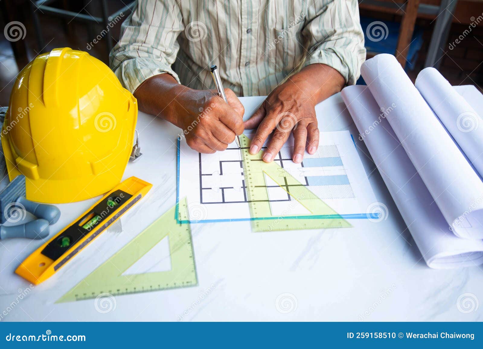 Architect Designing Project at Construction Site with Blueprint Stock ...