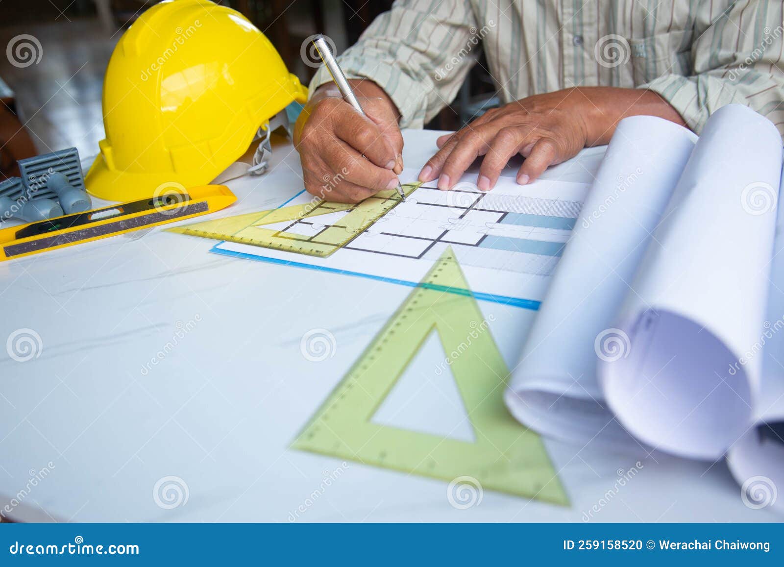 Architect Designing Project at Construction Site with Blueprint Stock ...