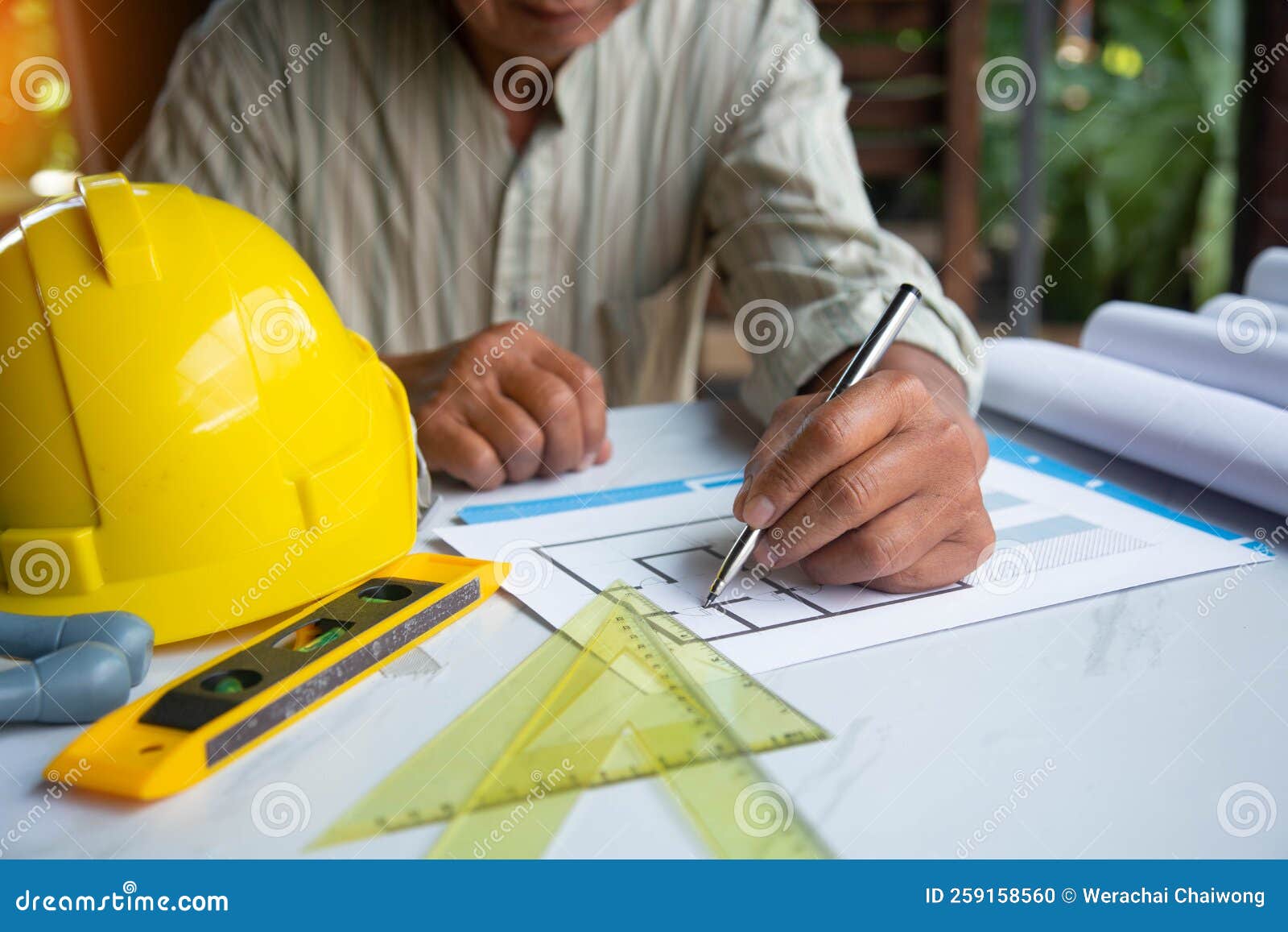 Architect Designing Project at Construction Site with Blueprint Stock ...