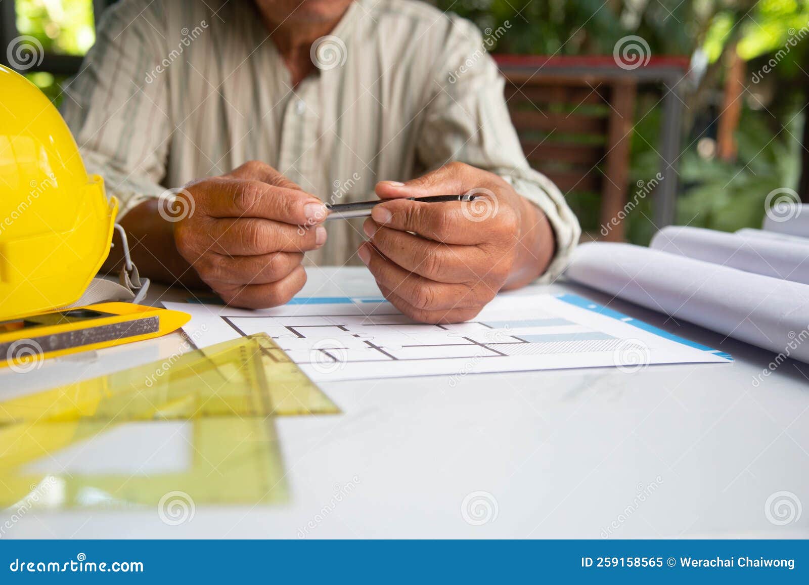 Architect Designing Project at Construction Site with Blueprint Stock ...