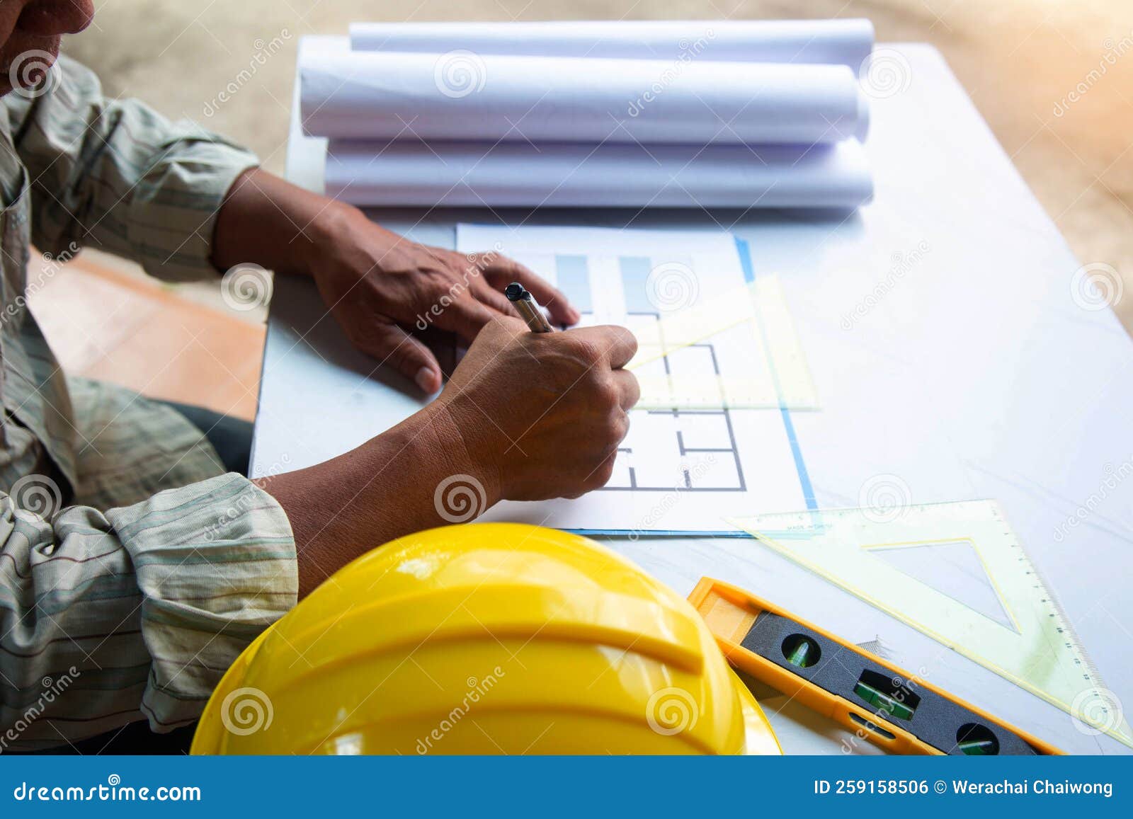 Architect Designing Project at Construction Site with Blueprint Stock ...