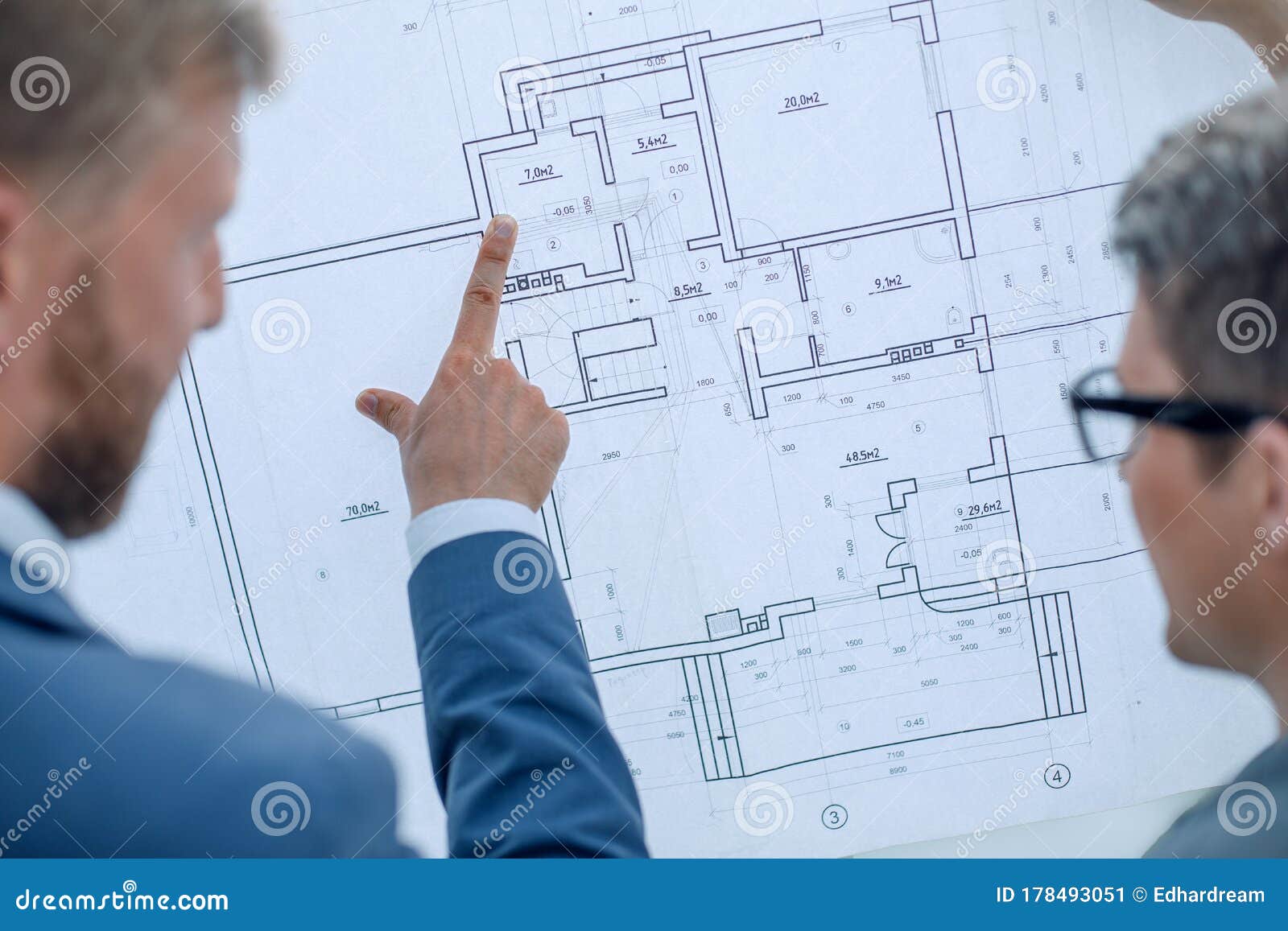 Architect Discussing with the Client a Blueprint of the Project. Stock ...