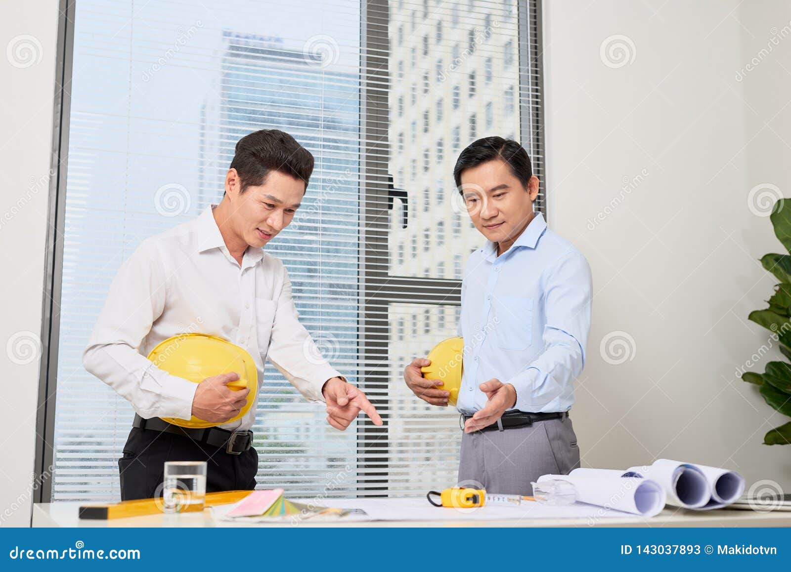 Architect Discussing Their Project in the Office with Partner Stock ...